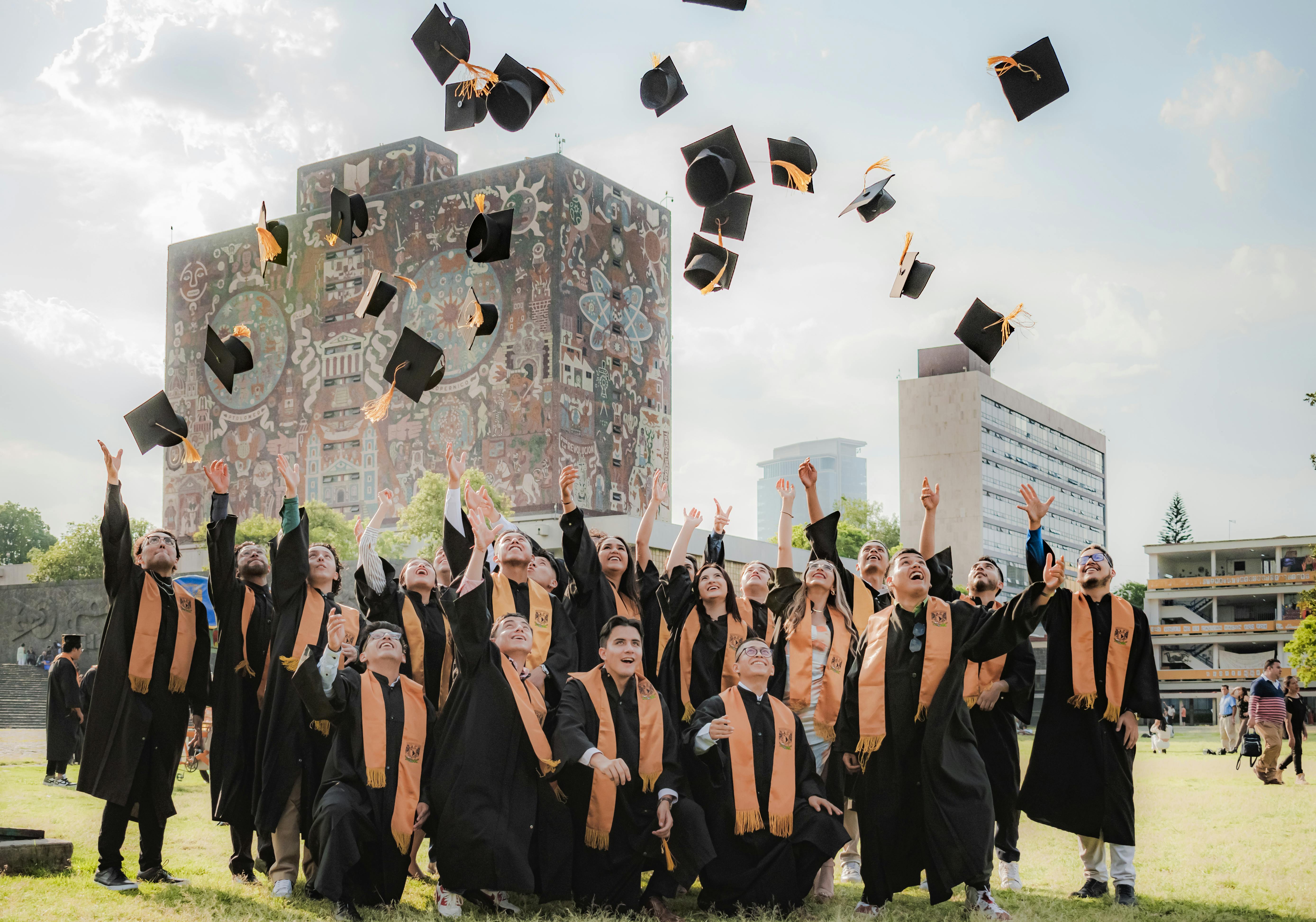 Smiling Graduates Throwing Up Academic Hats near UNAM Central Library ...