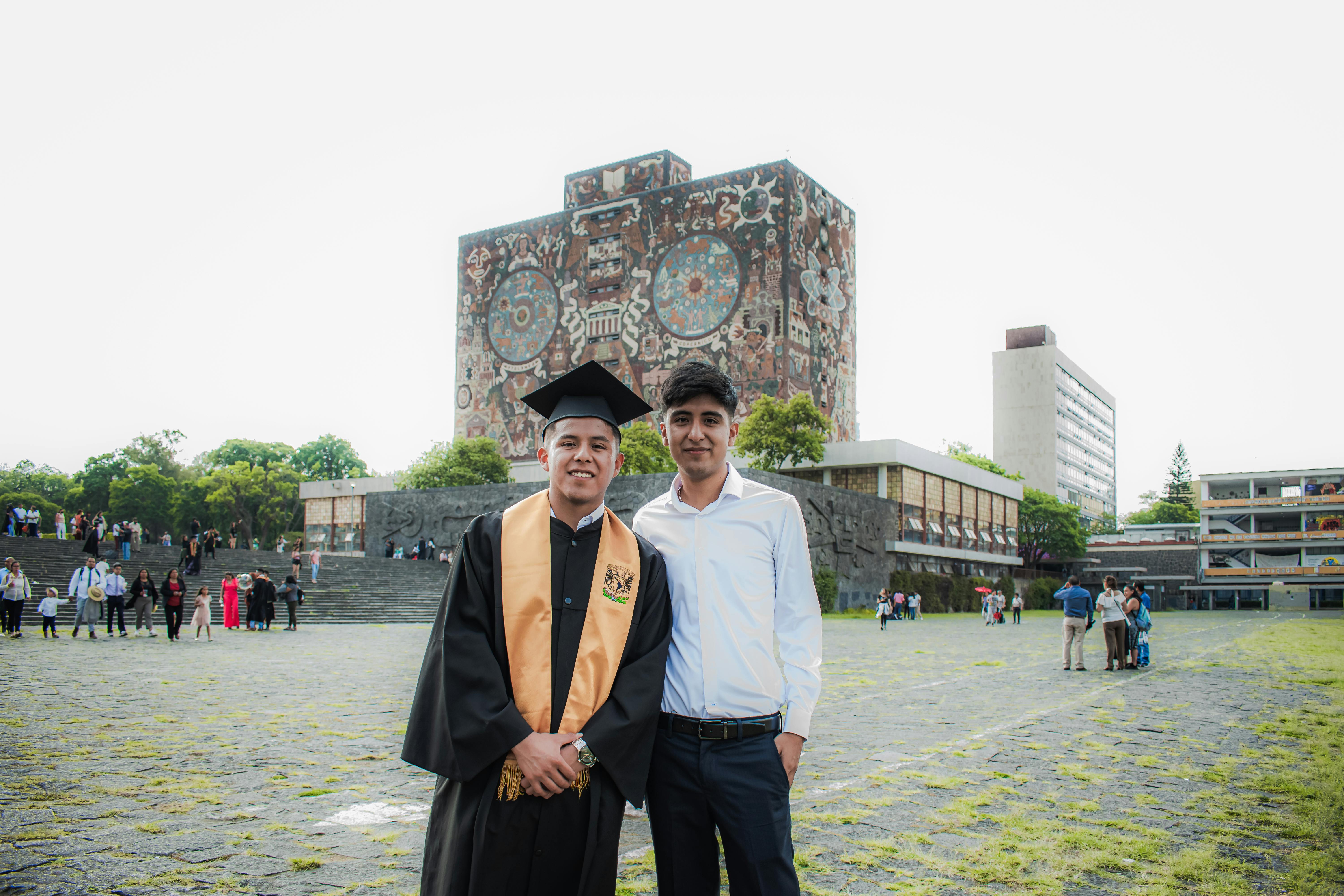 Men in Academic Dress Standing while Holding Diplomat · Free Stock Photo