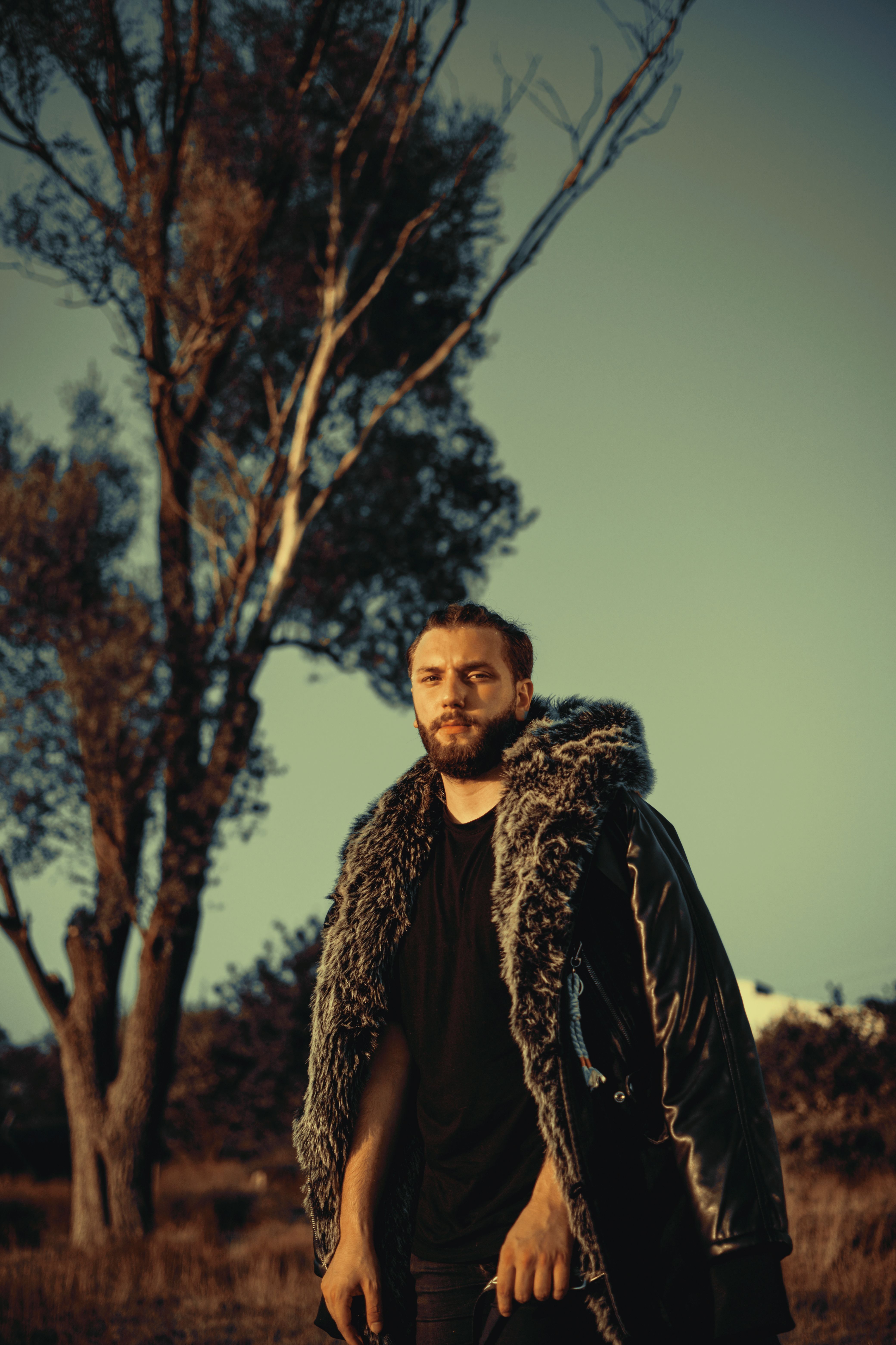 Young Man Wearing a Furry Coat Standing Outside · Free Stock Photo