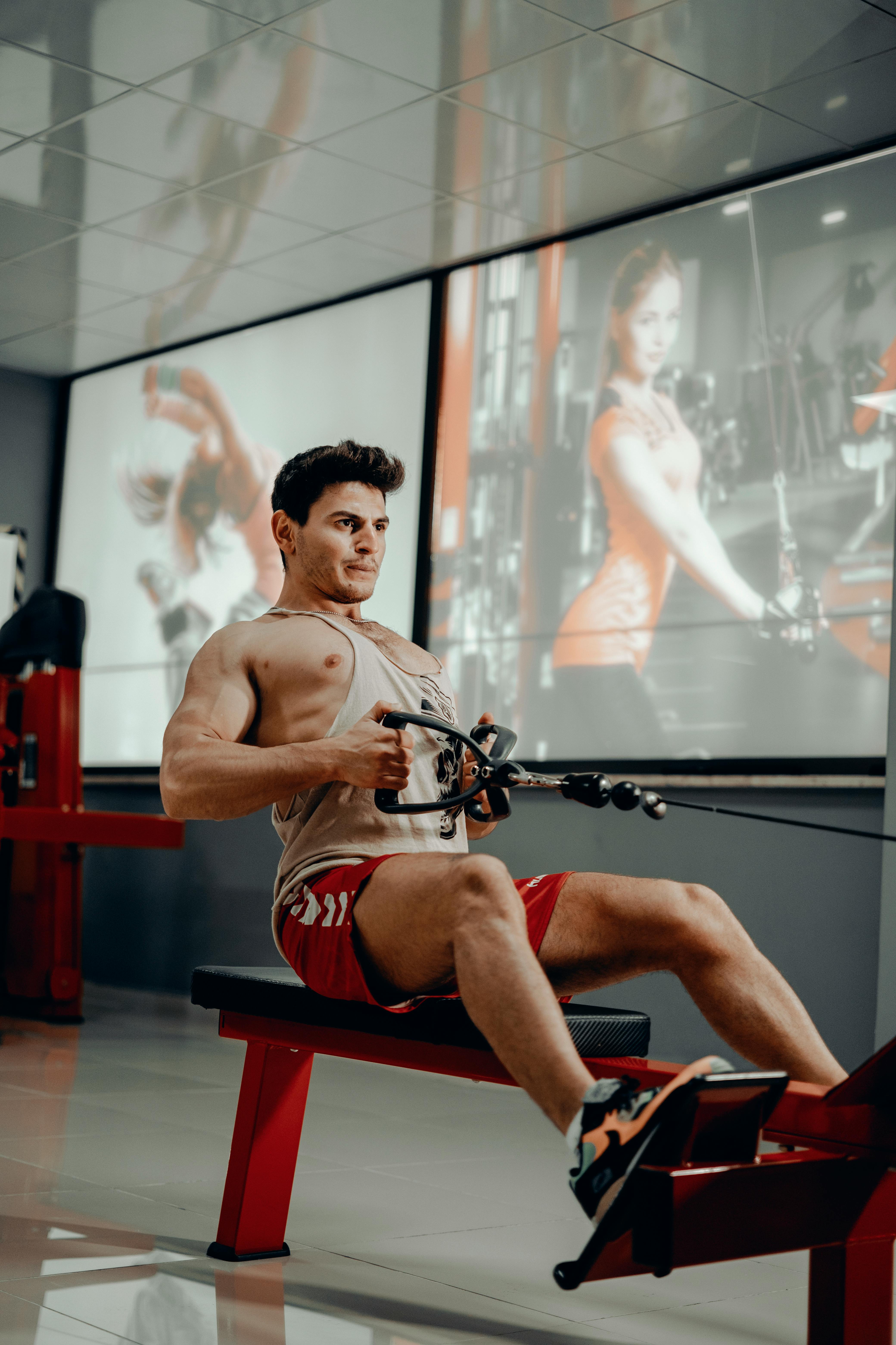 Man Sitting and Practicing at Gym · Free Stock Photo