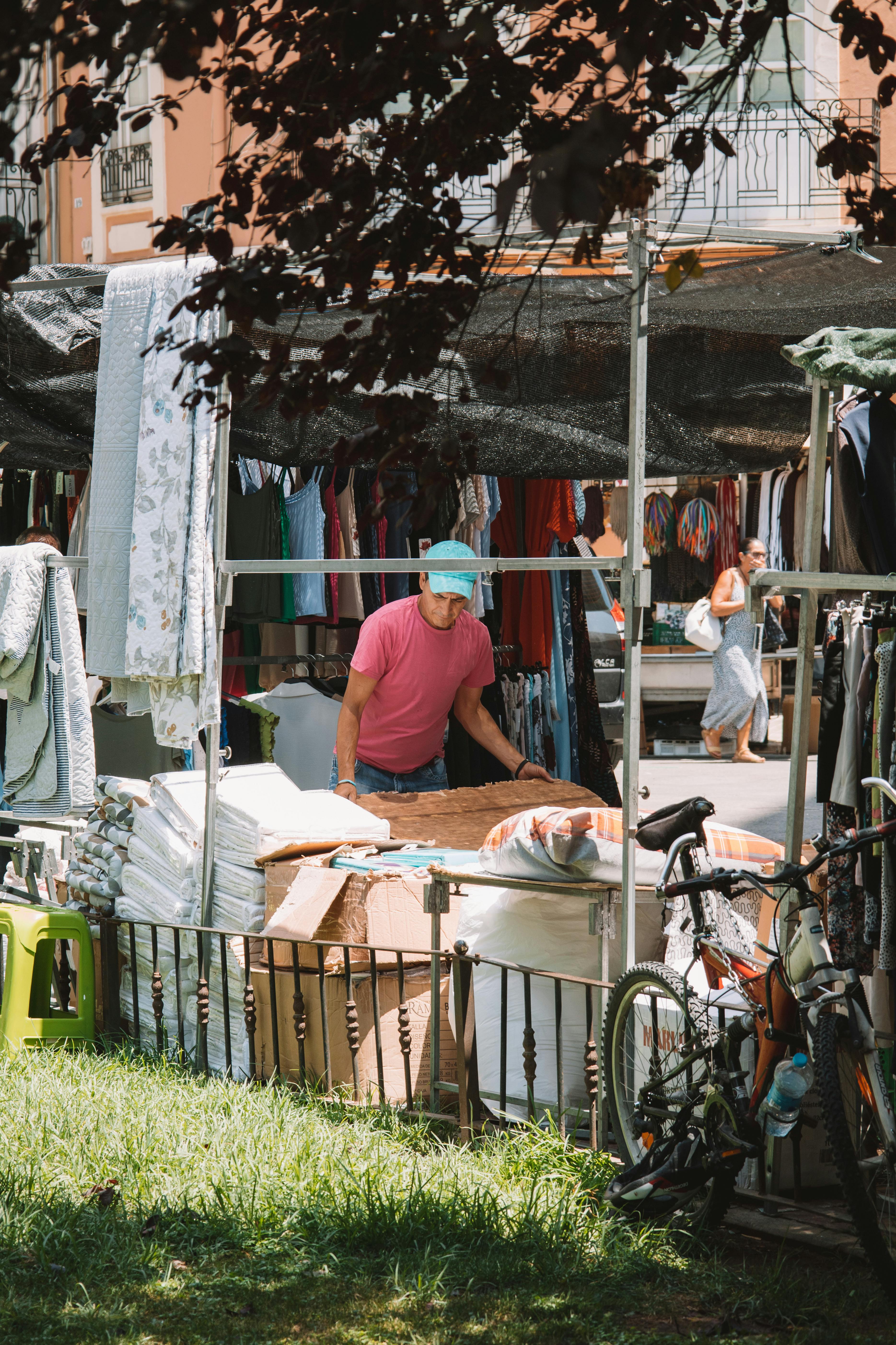 Man Selling Clothes on a Market · Free Stock Photo