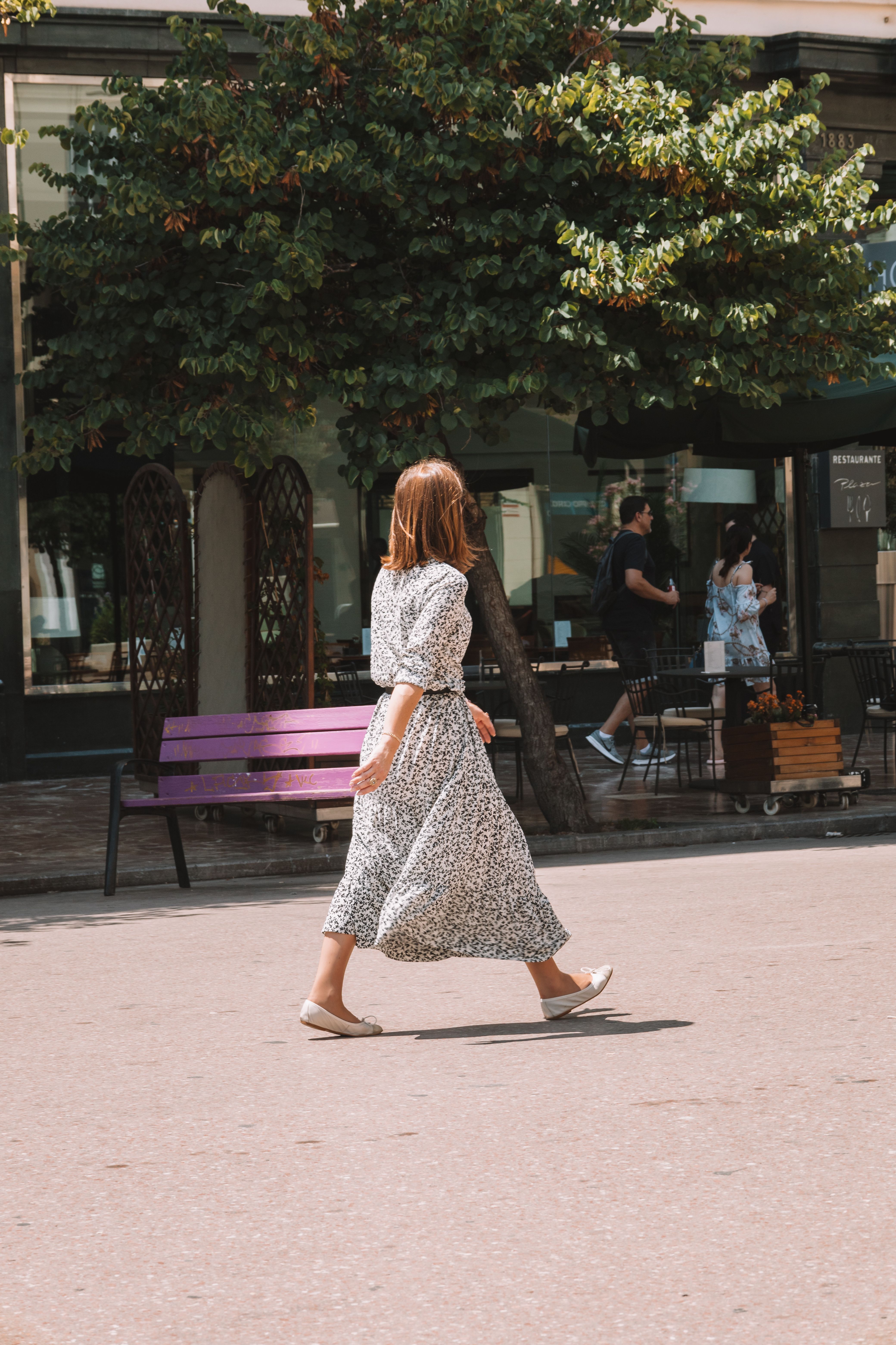 Woman Walking on a Pavement · Free Stock Photo