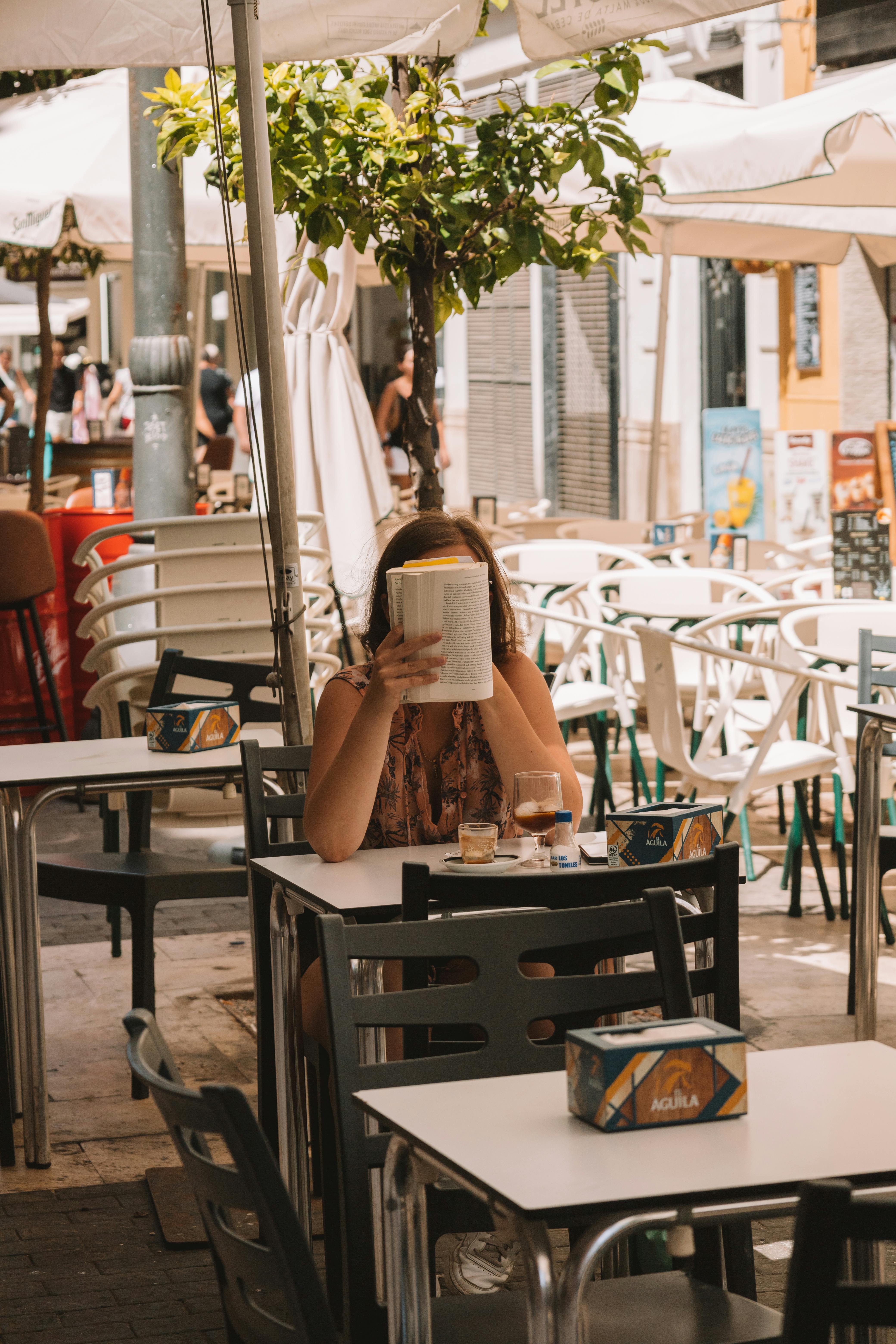 Woman Sitting in Restaurant · Free Stock Photo