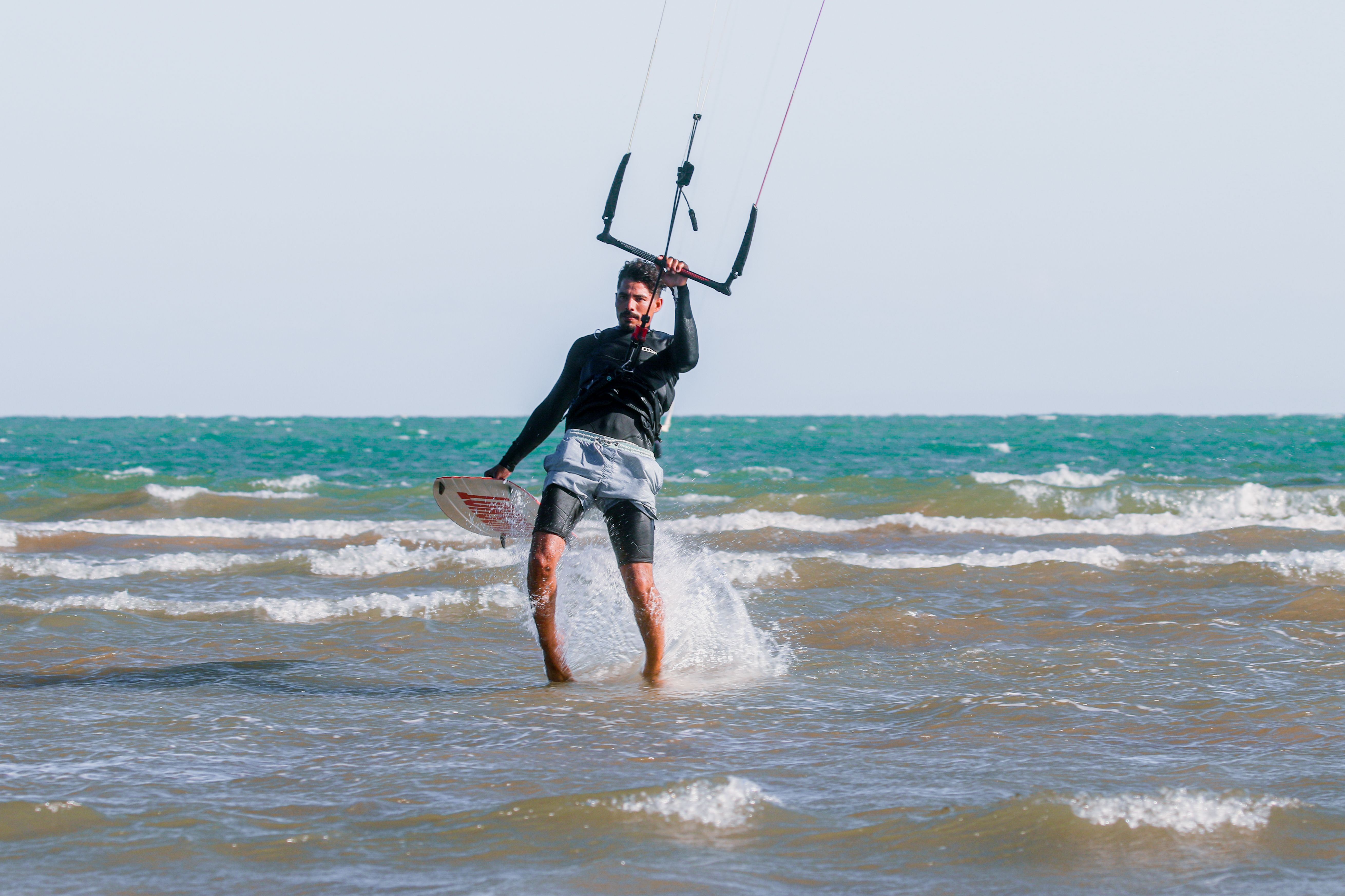 A Man Walking out of the Sea after Windsurfing · Free Stock Photo