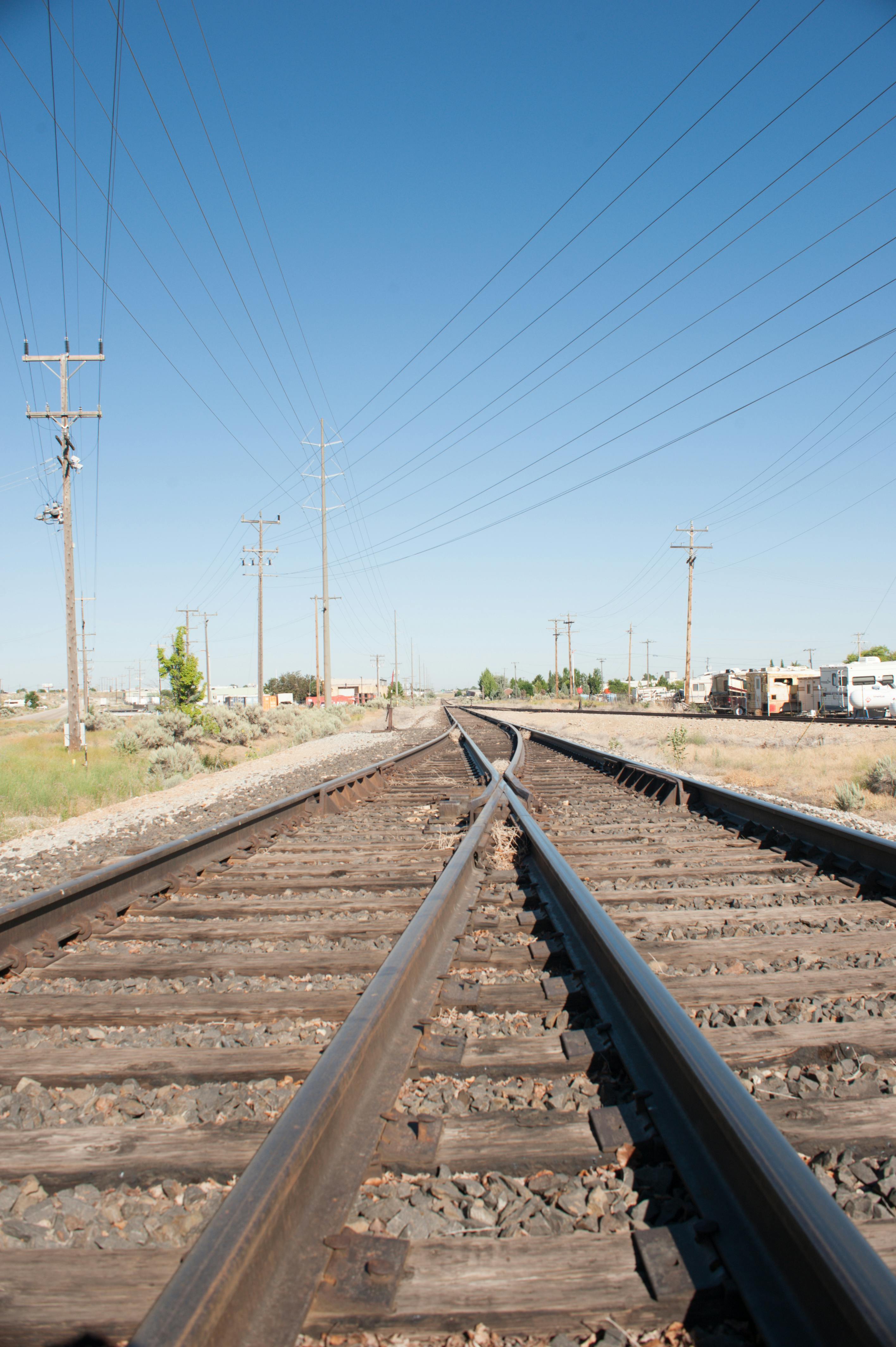 Sunlit Railway Tracks in Countryside · Free Stock Photo
