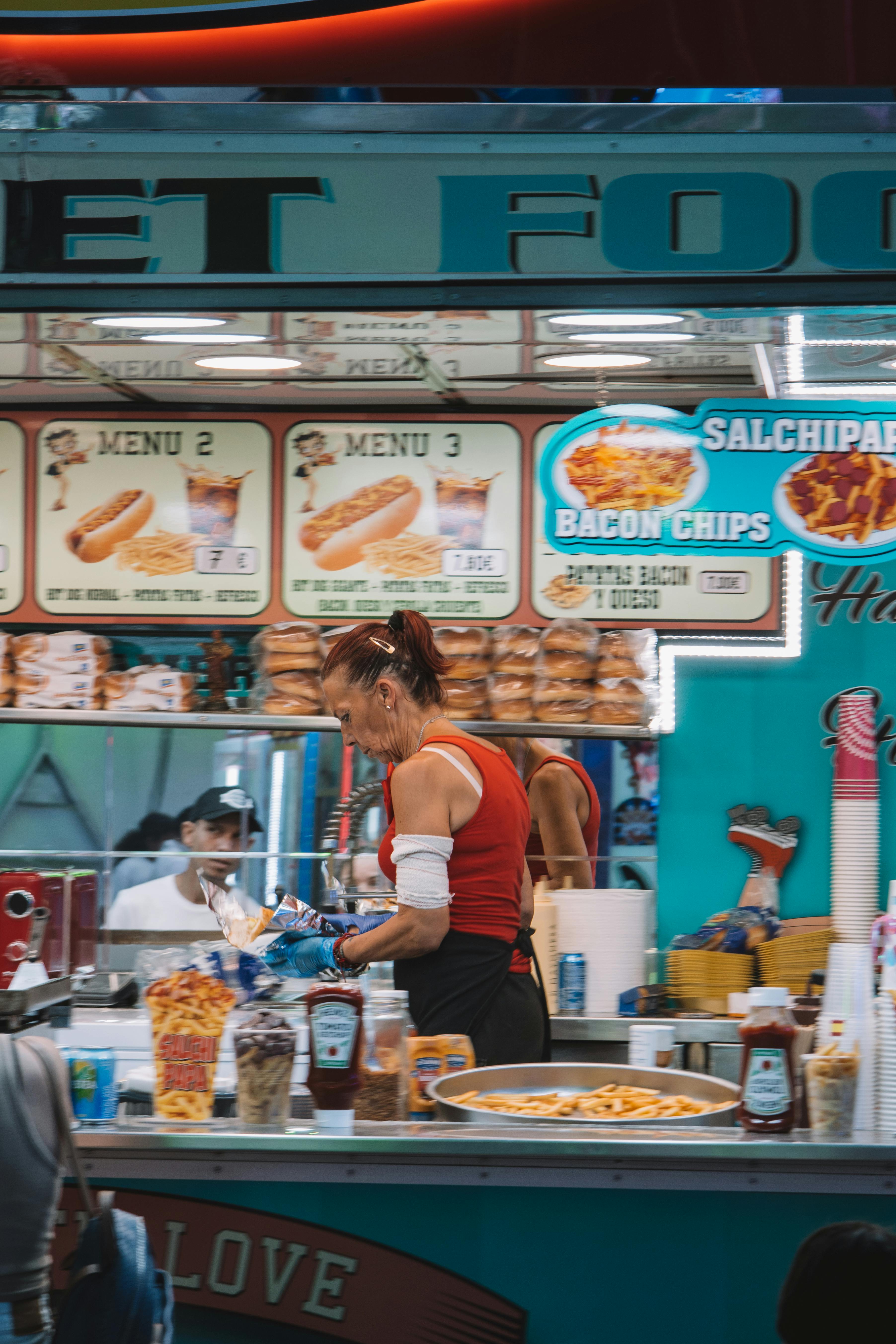Woman Cooking in a Booth · Free Stock Photo