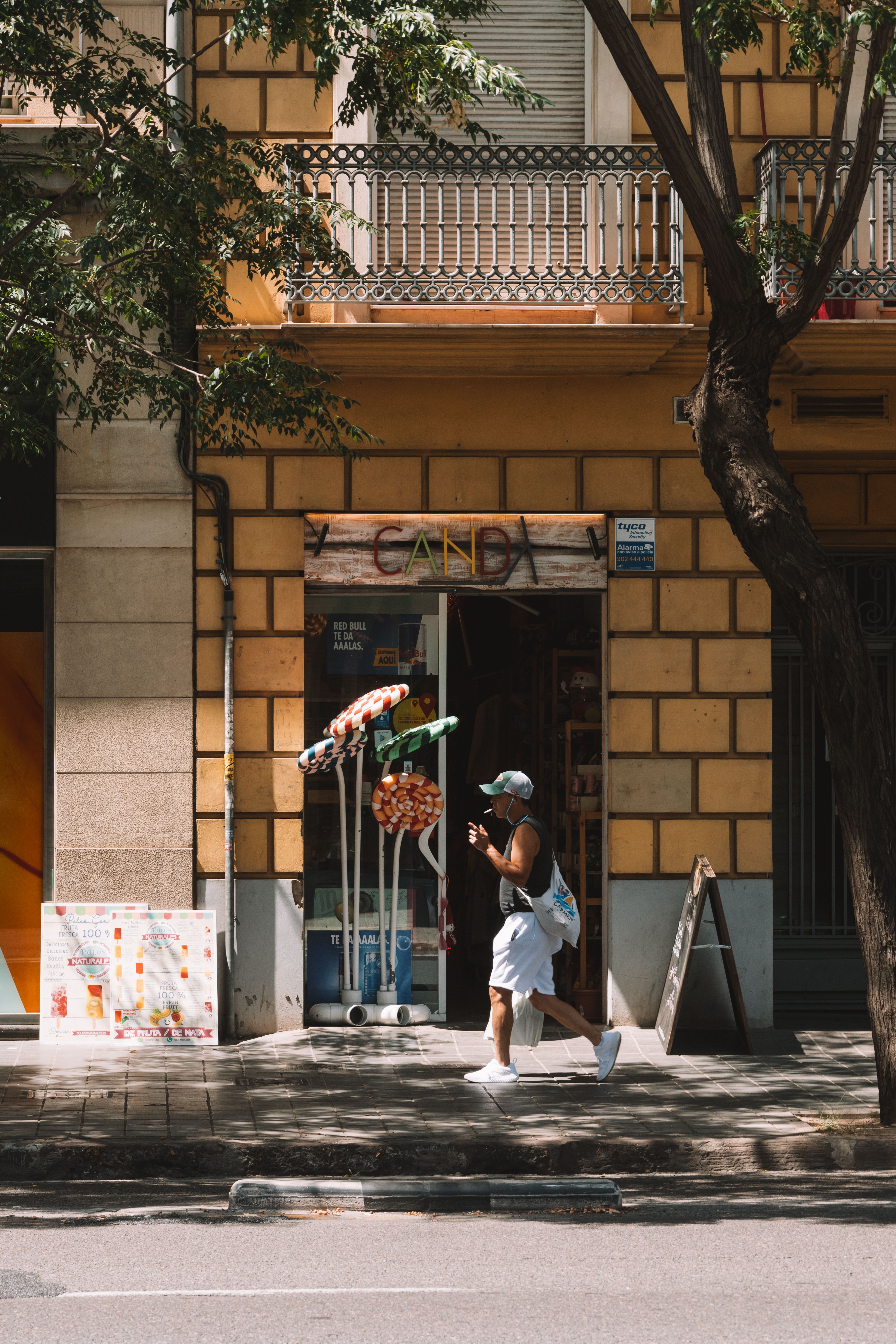 Man Walking by a Candy Shop · Free Stock Photo
