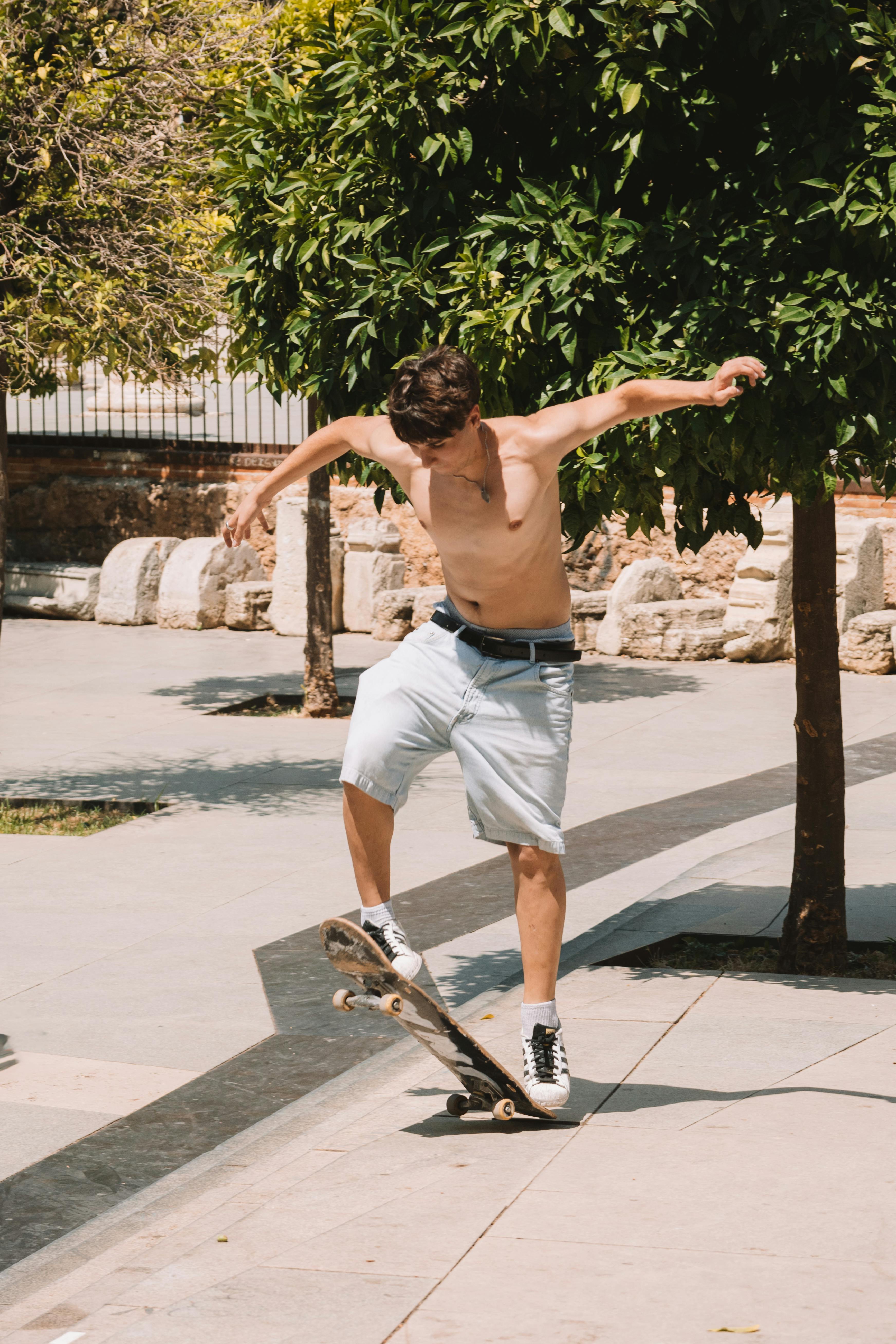 Man Riding Skateboard on Road · Free Stock Photo