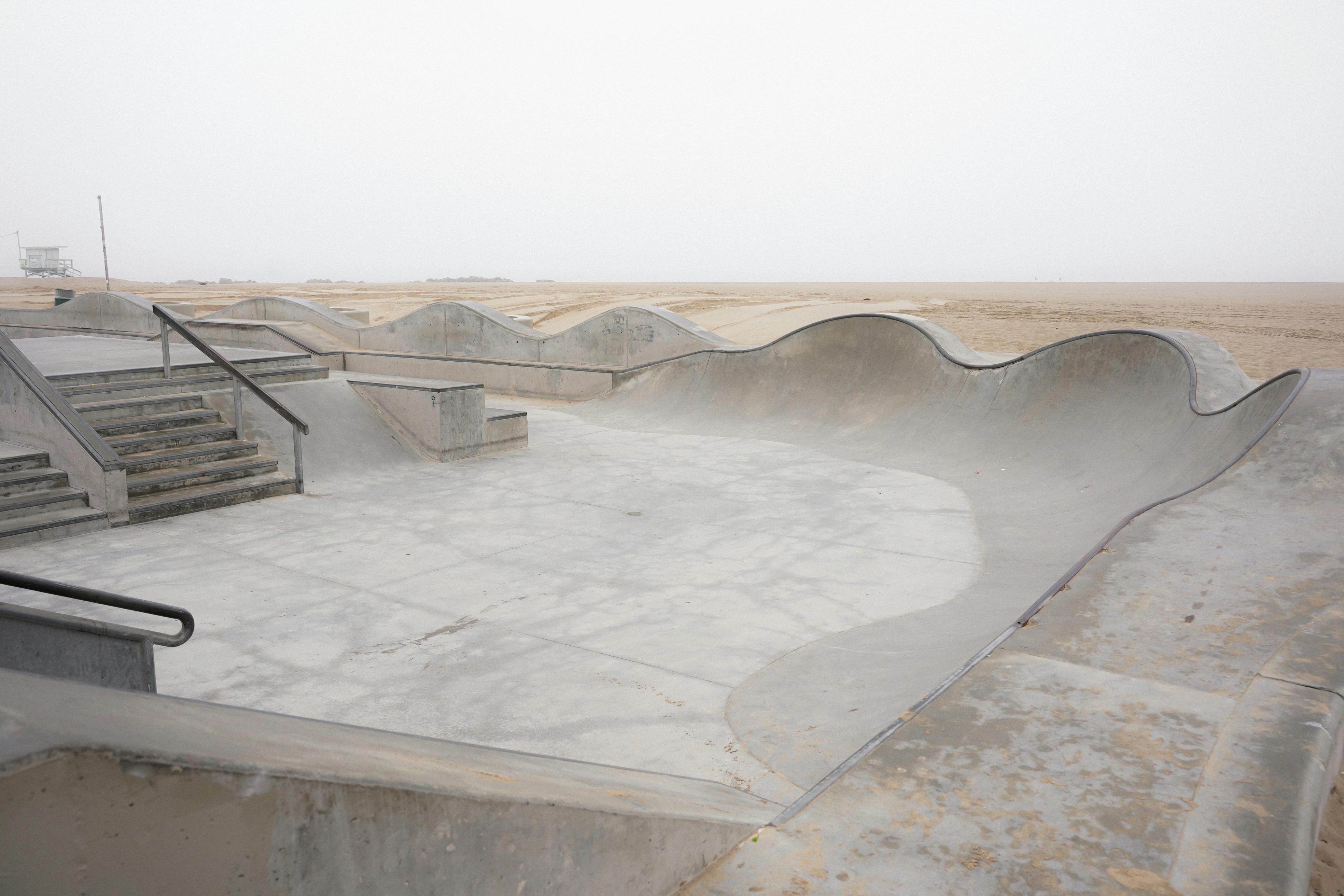 A skateboard ramp with stairs and a concrete bowl · Free Stock Photo