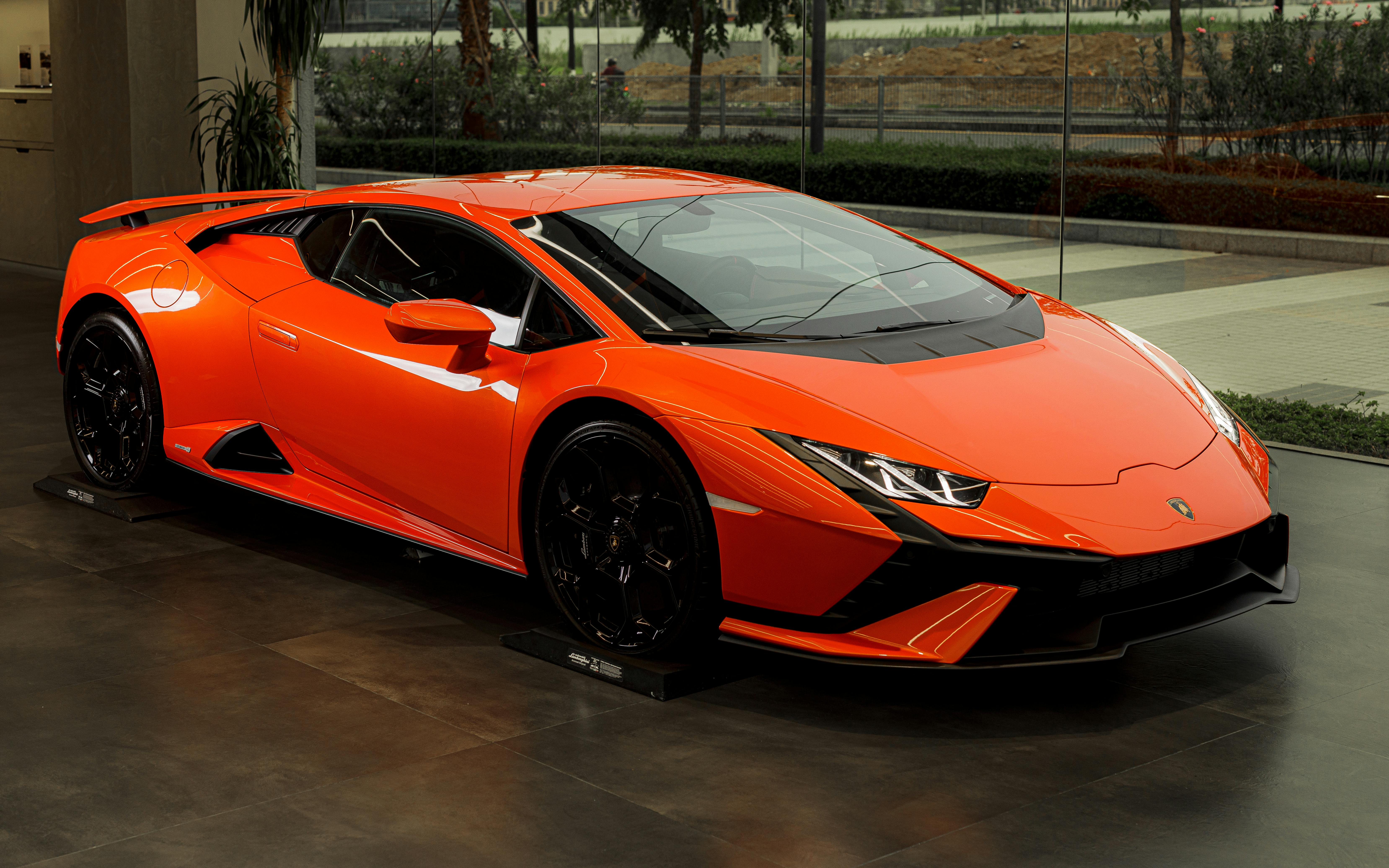 Orange Lamborghini Huracan Sports Car Standing on Pads · Free Stock Photo