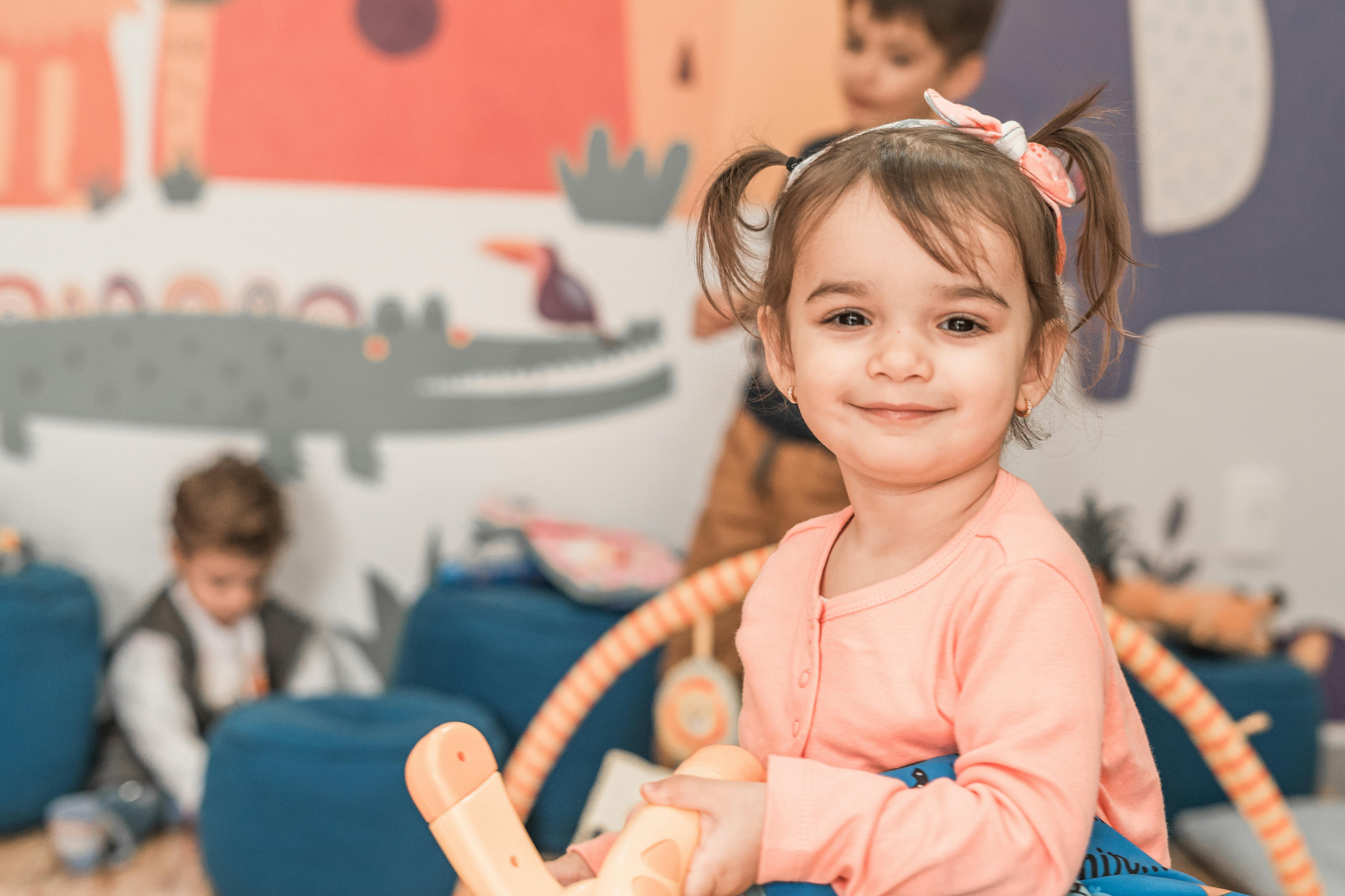 Portrait of Smiling Girl in Preschool · Free Stock Photo