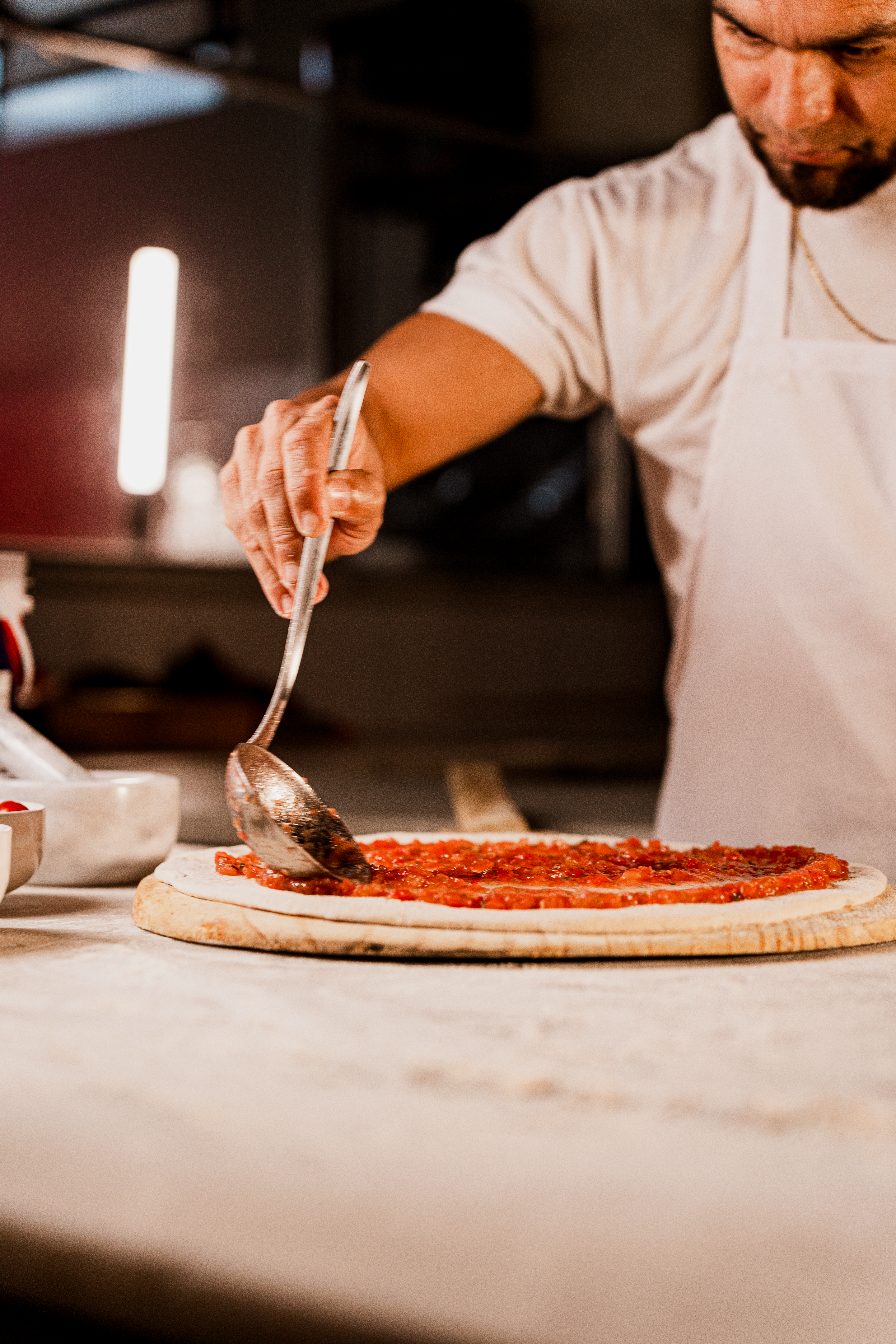 Close-Up Shot of a Person Making Pizza · Free Stock Photo