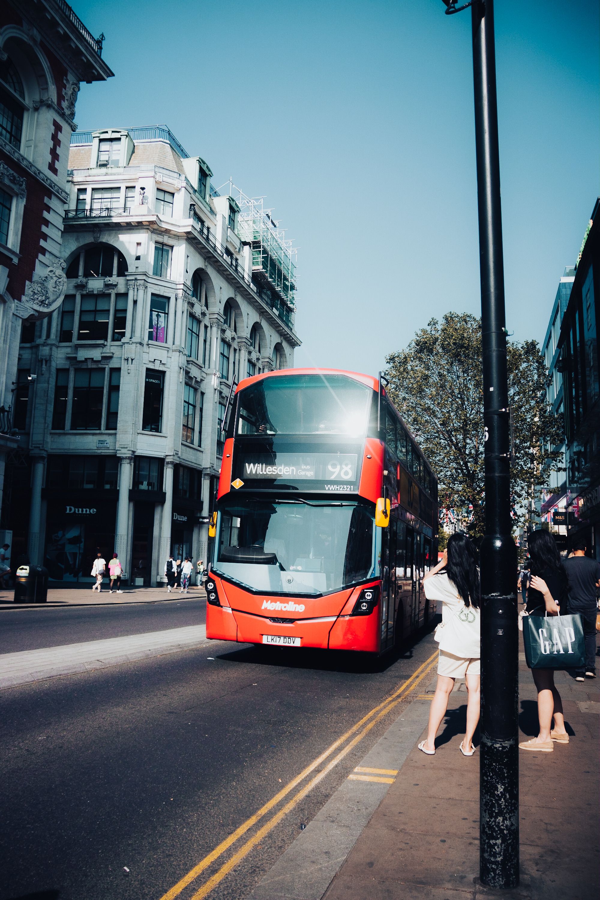 Low Angle Photo of People Waiting for the Red Bus to Pass · Free Stock ...