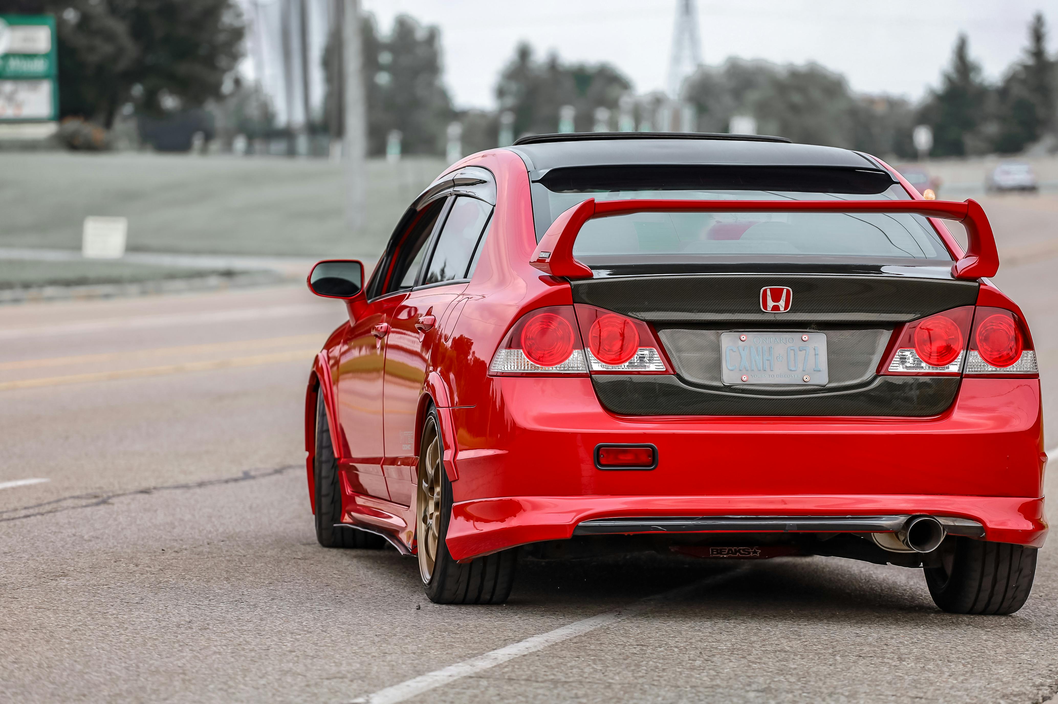 Rear View of a Red Honda Civic Car on a Road · Free Stock Photo