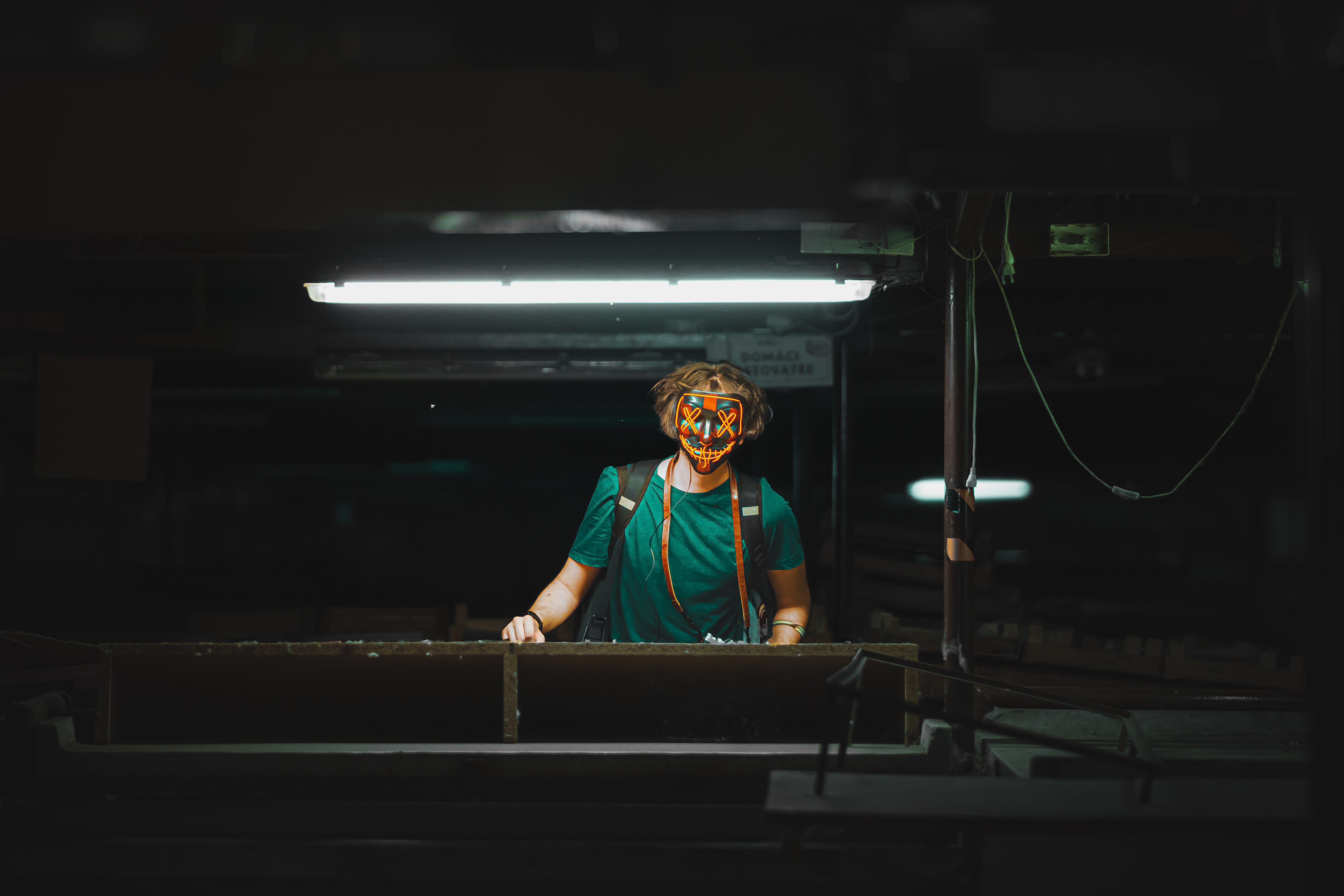 Man in a Mask Standing under the Light · Free Stock Photo