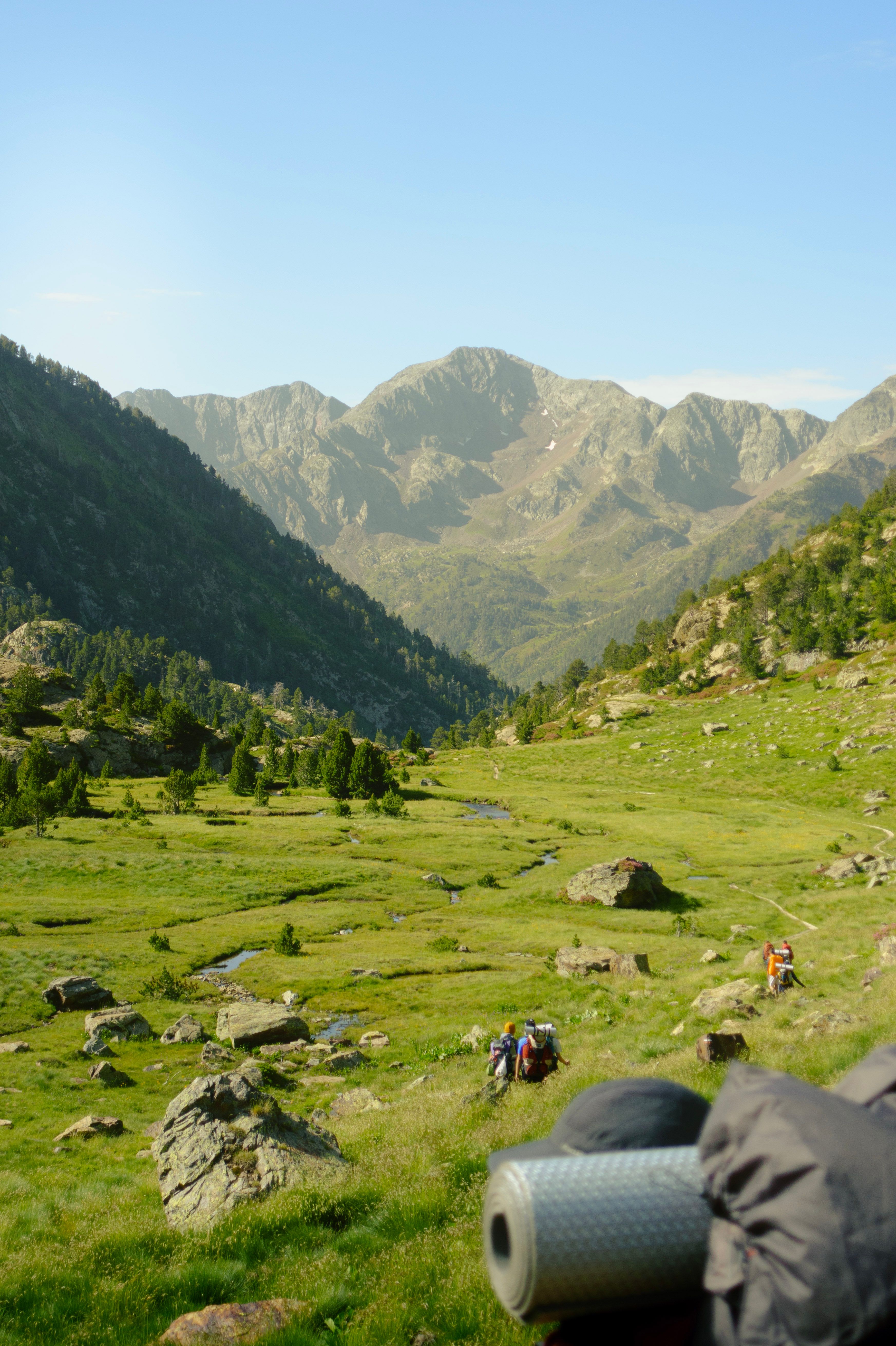 Hikers Exploring Scenic Mountain Valley · Free Stock Photo