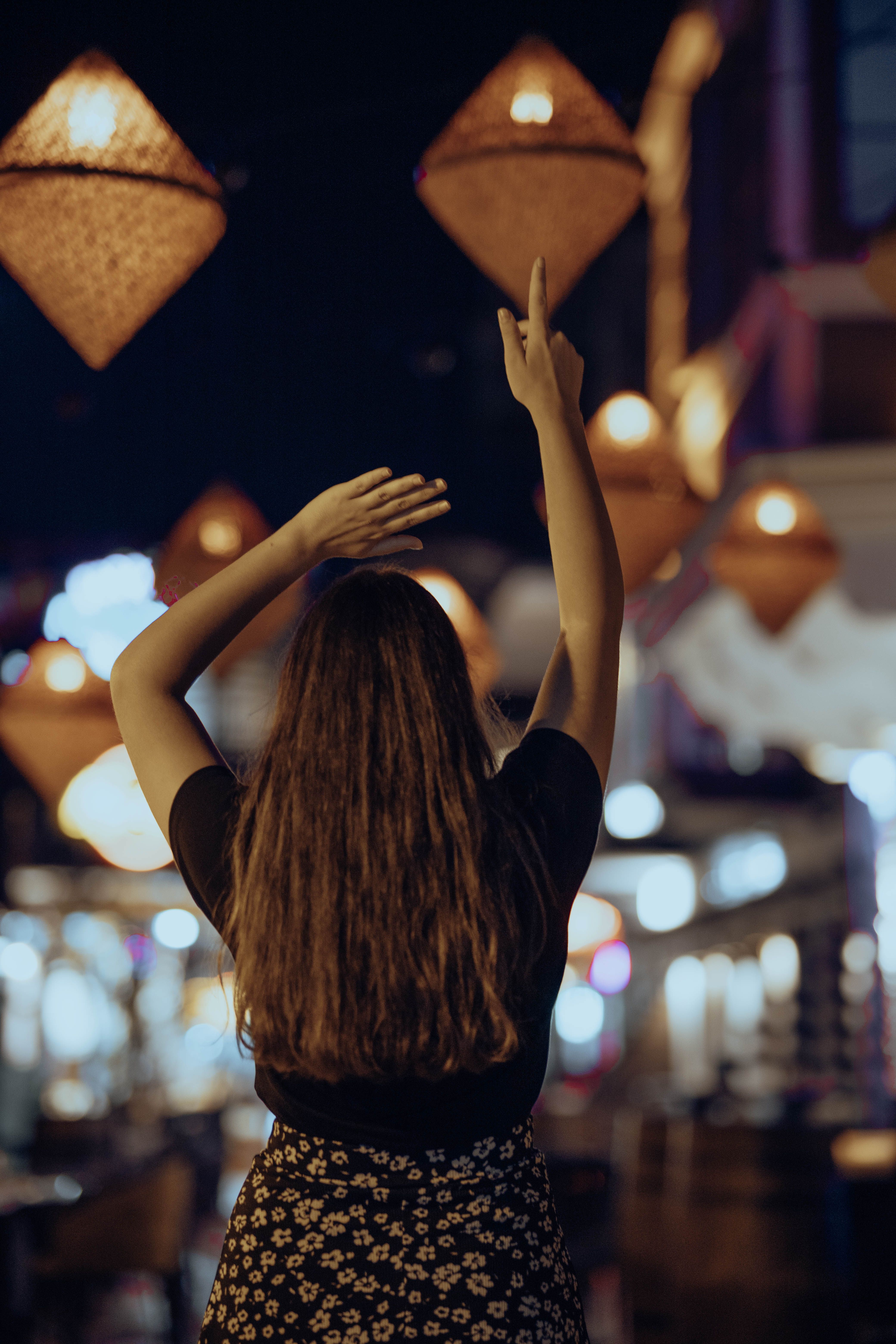 Back View of Woman Standing with Arms Raised · Free Stock Photo