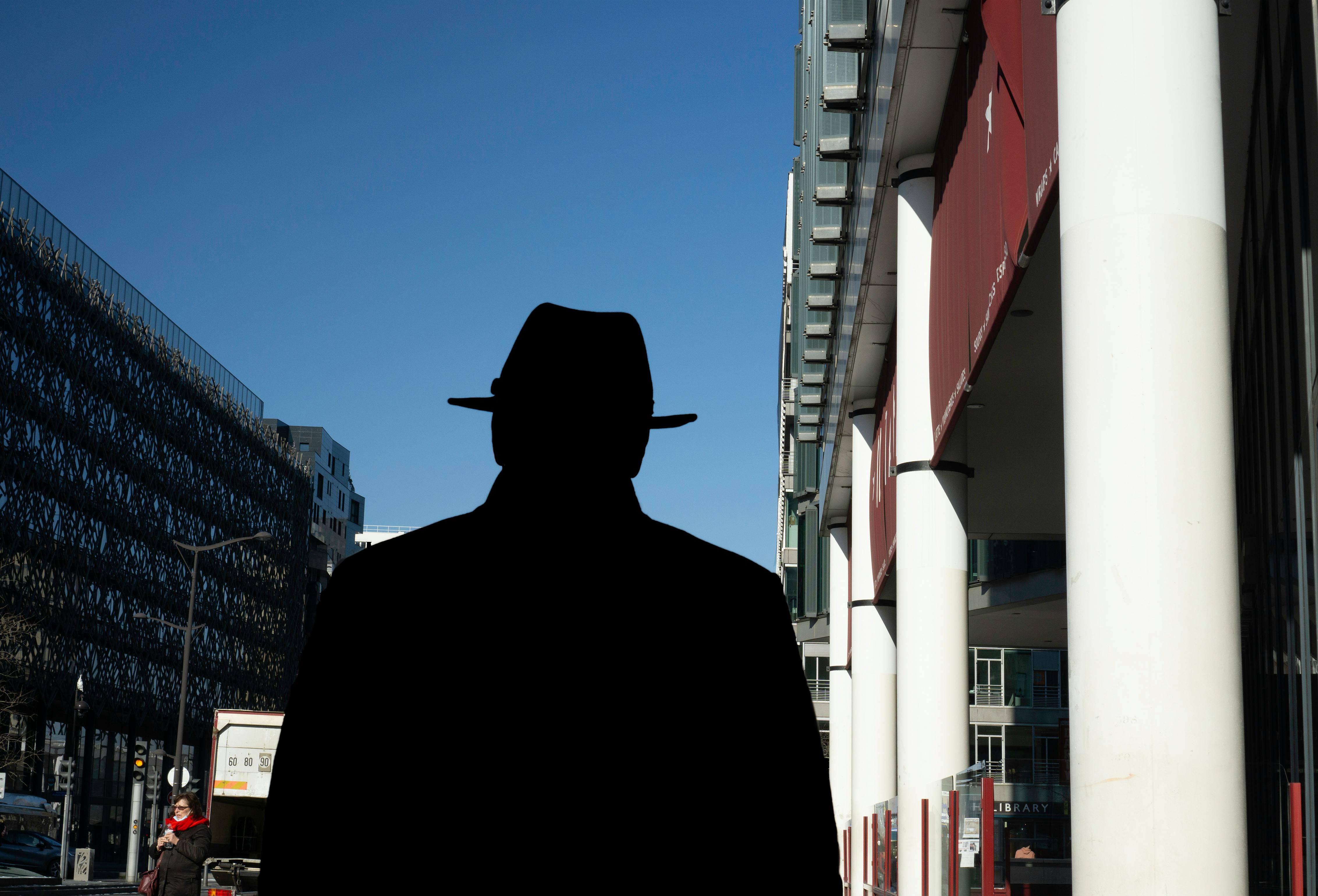 Silhouette of Man in Hat · Free Stock Photo