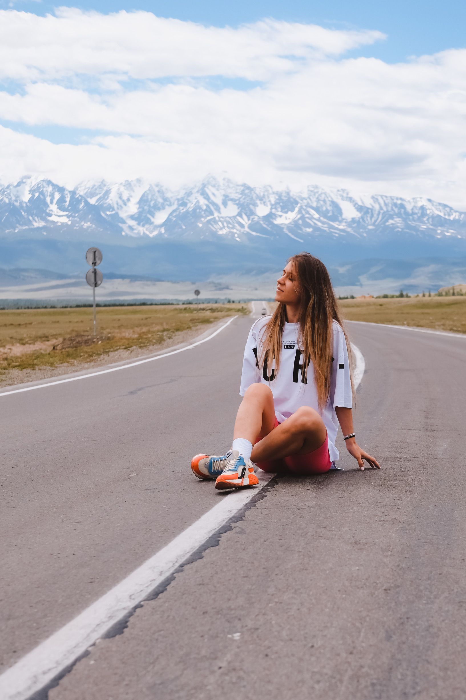 Woman Sitting on Road in Countryside · Free Stock Photo