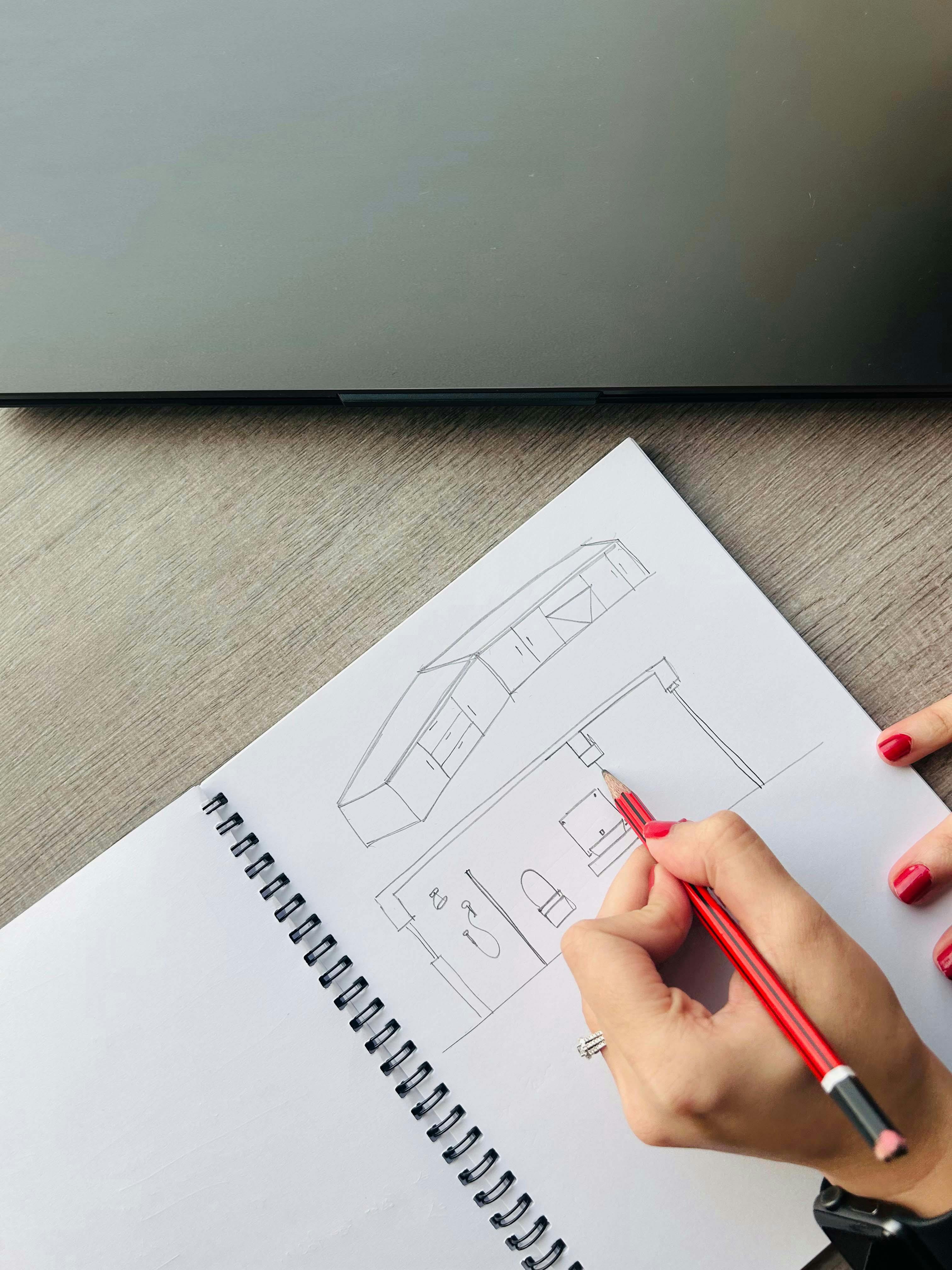 Woman Hand Drawing in Notebook · Free Stock Photo