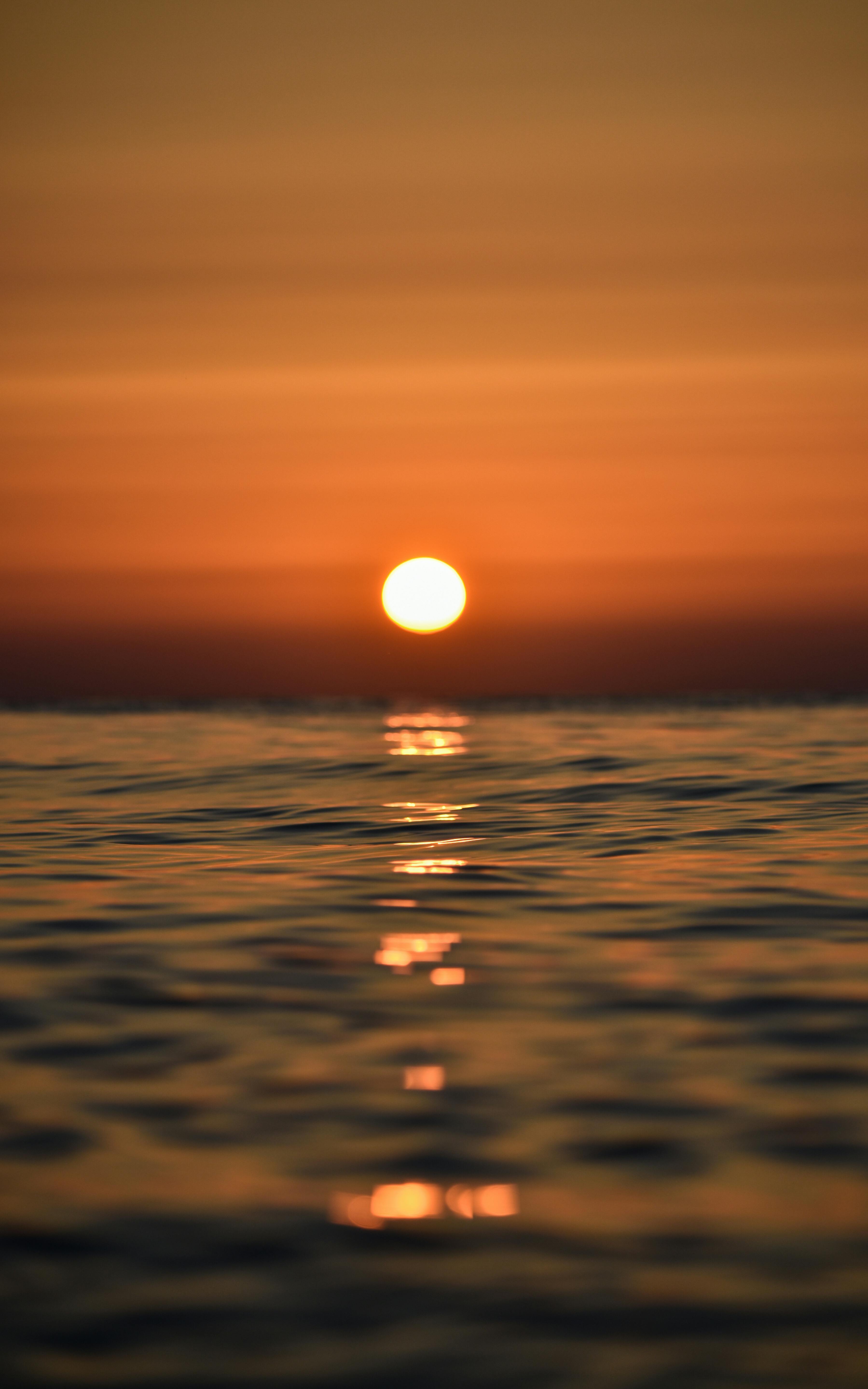 Sunset over the Sea Photographed from the Sea Level · Free Stock Photo