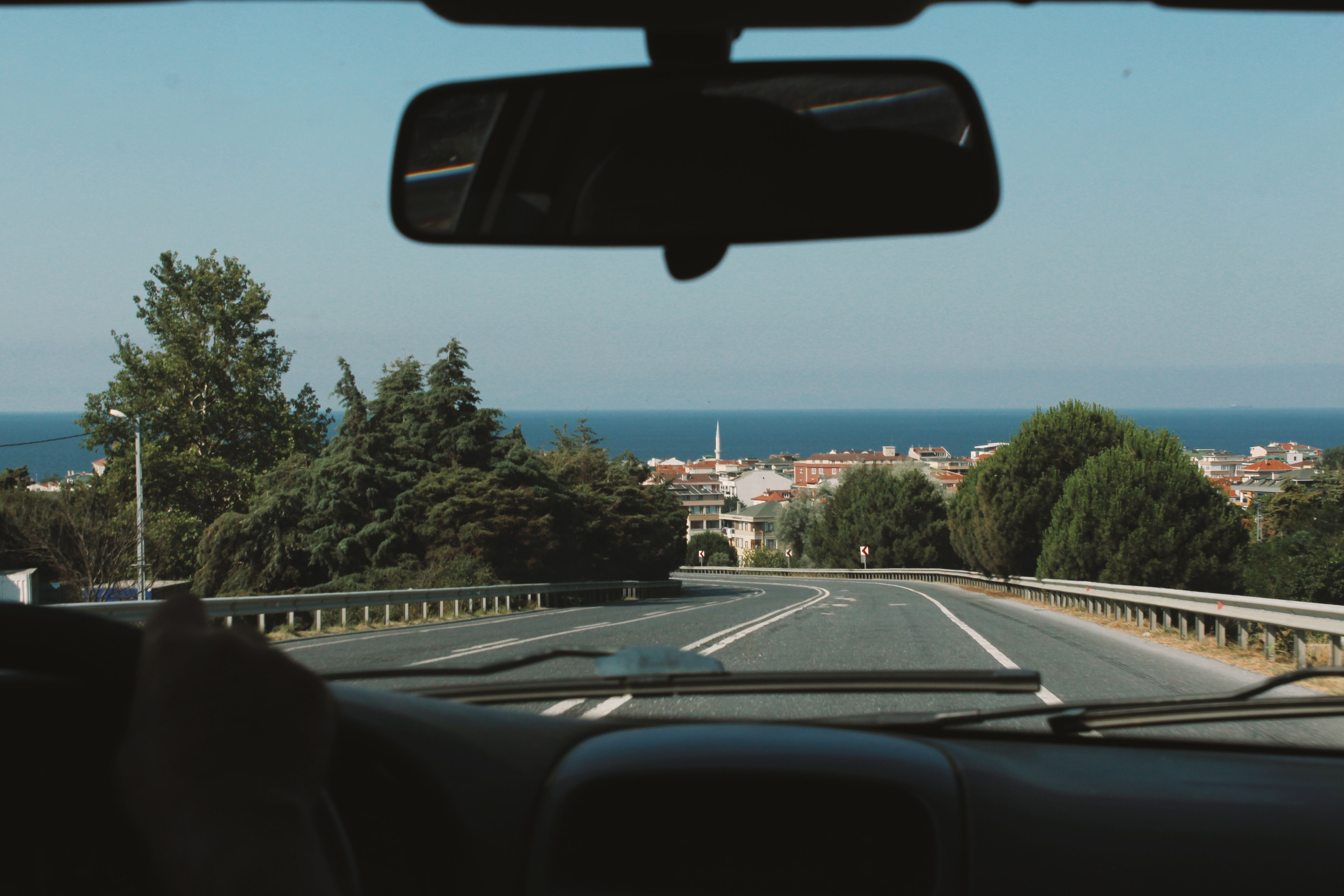 Windshield View from a Car Driving towards a Seaside Town · Free Stock ...