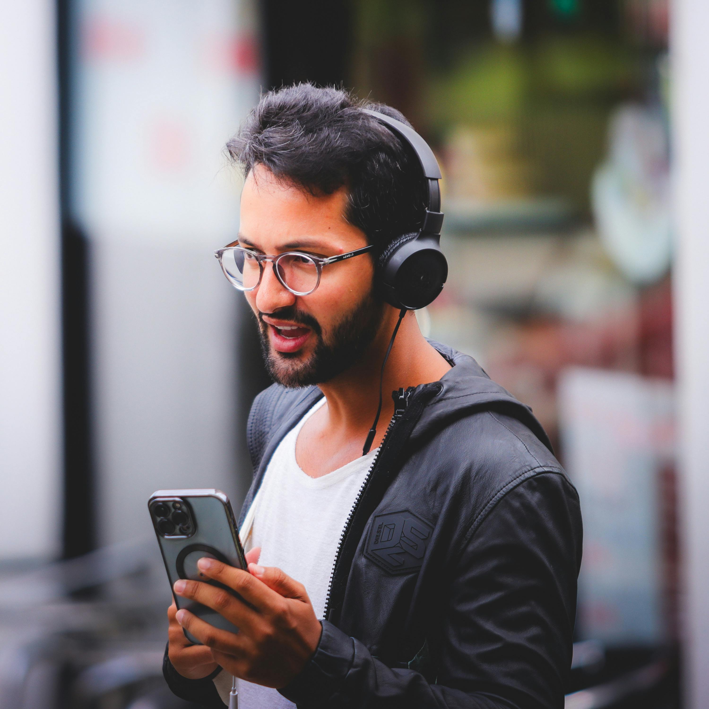 Man Talking on Smartphone with Headphones · Free Stock Photo