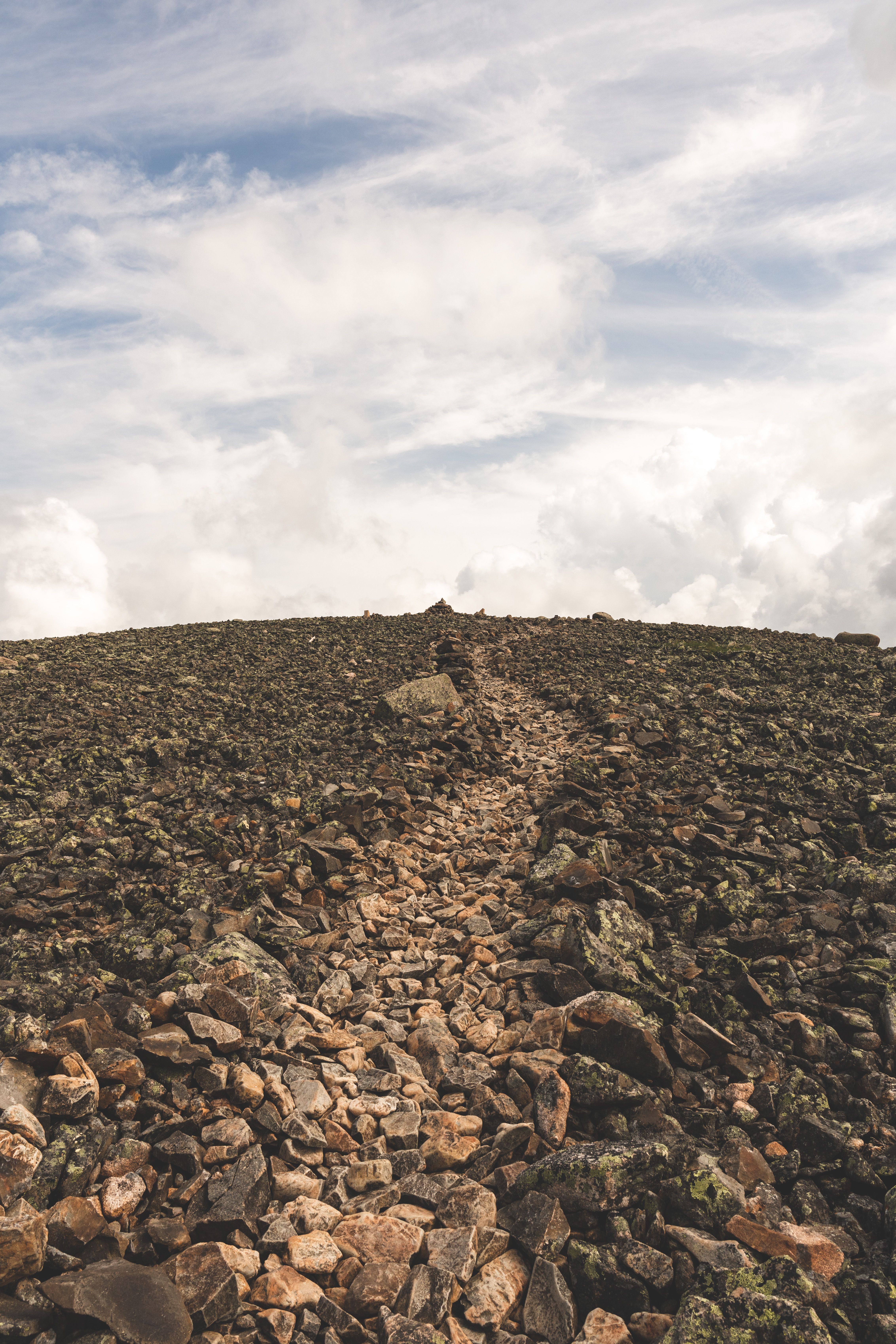 A trail leading up to a rocky hill · Free Stock Photo