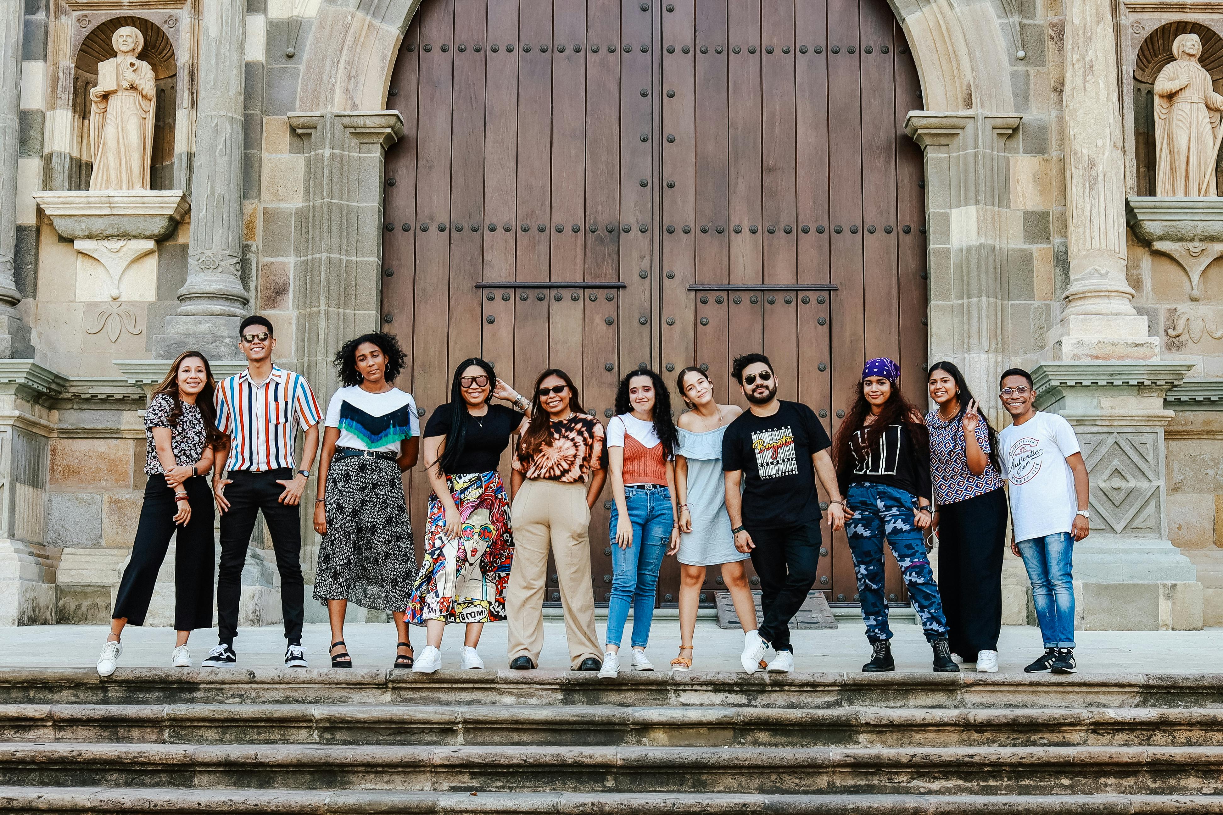 Group of Young People Posing on the Church Steps · Free Stock Photo