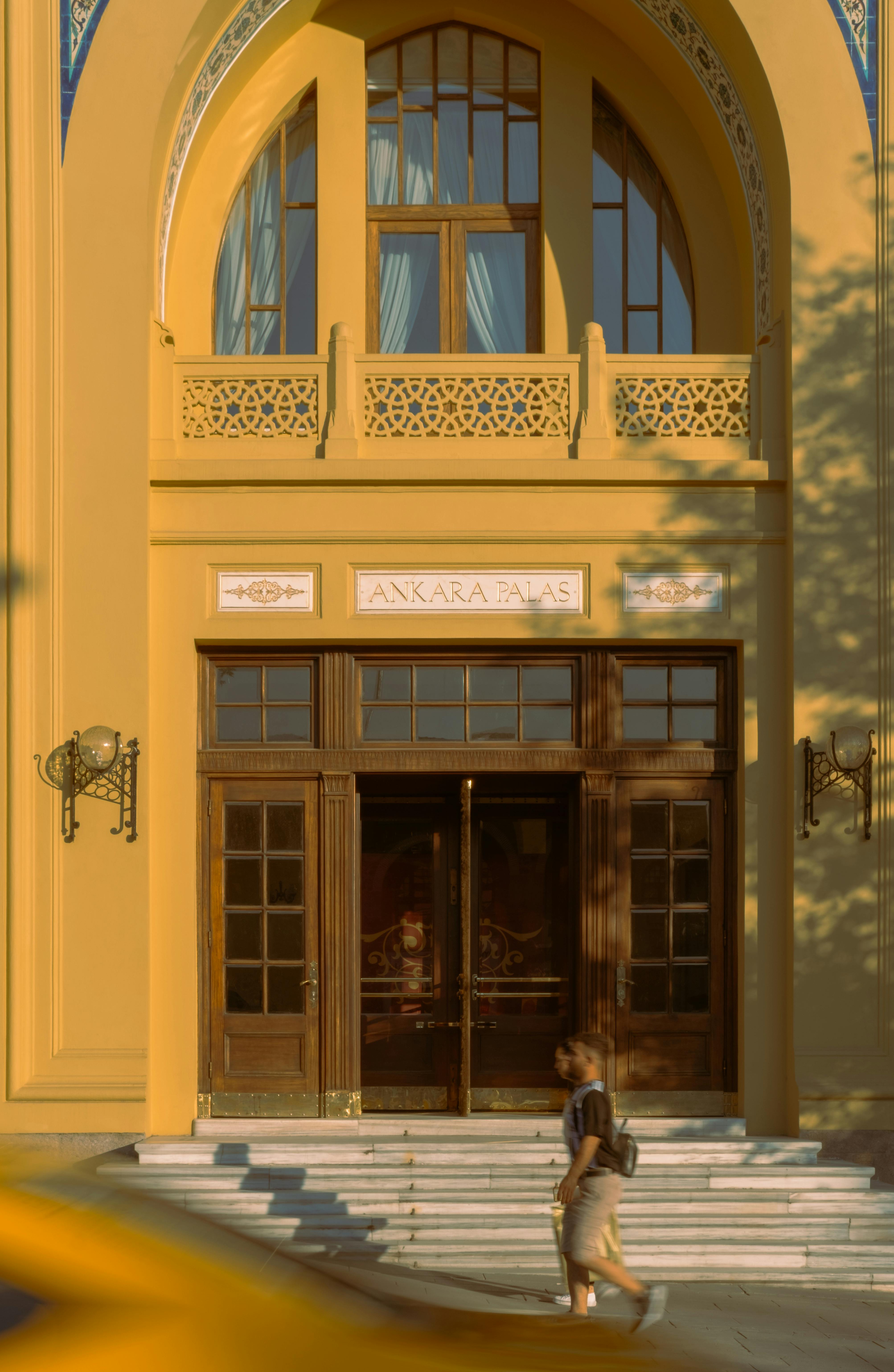 People Walking on a Street by the Entrance to Ankara Palas Hotel ...