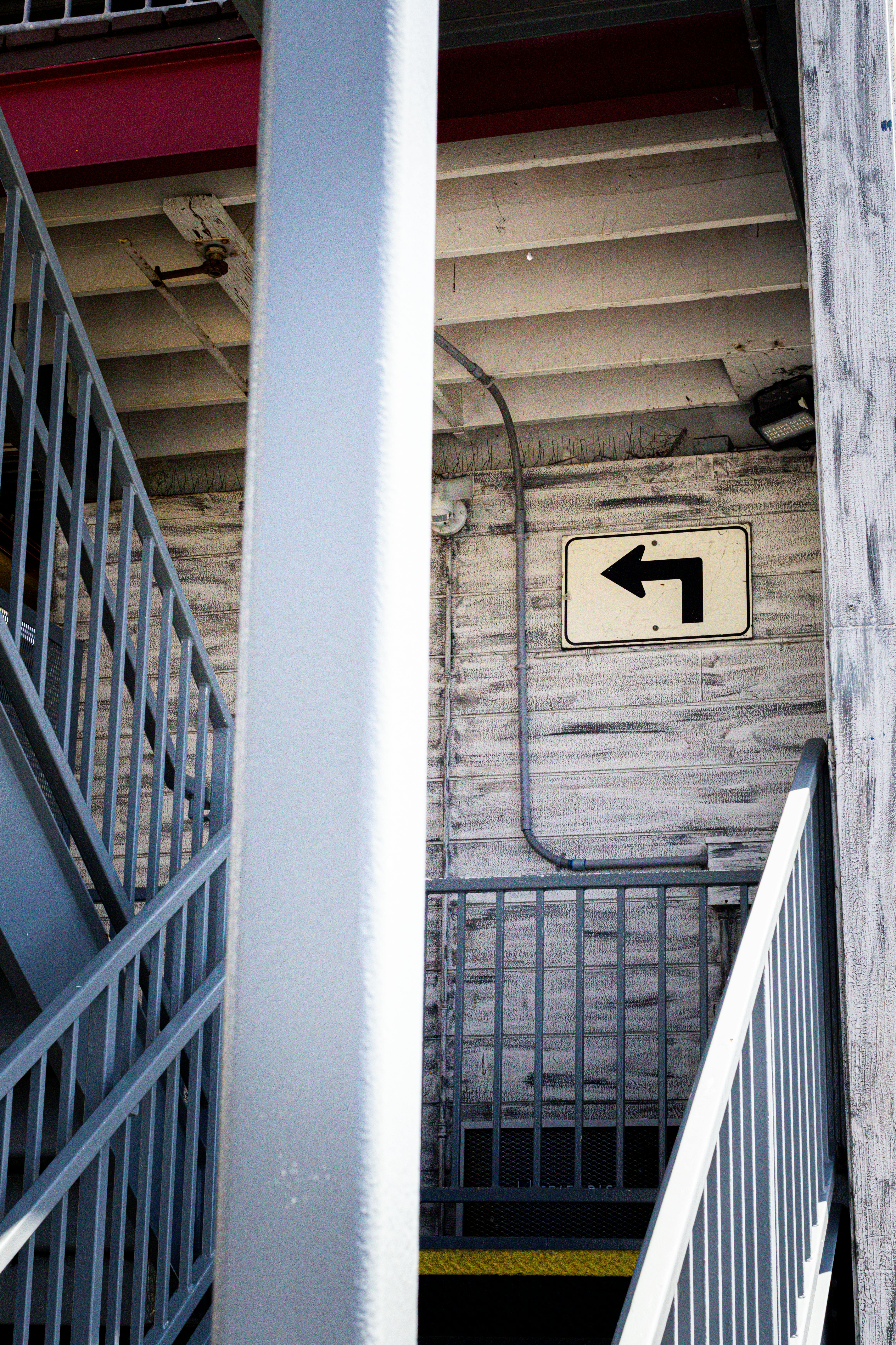 Directional Sign on Wall on Stairs · Free Stock Photo