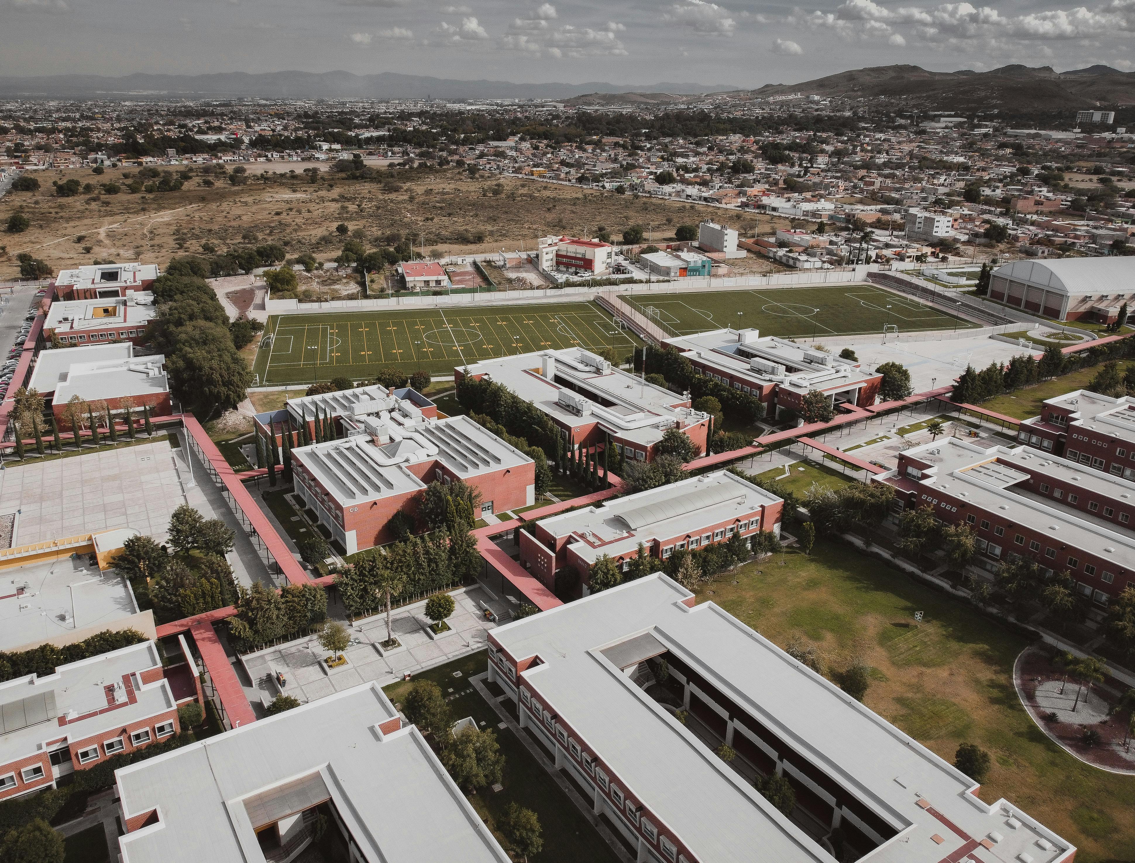 Aerial view of a school campus with a soccer field · Free Stock Photo