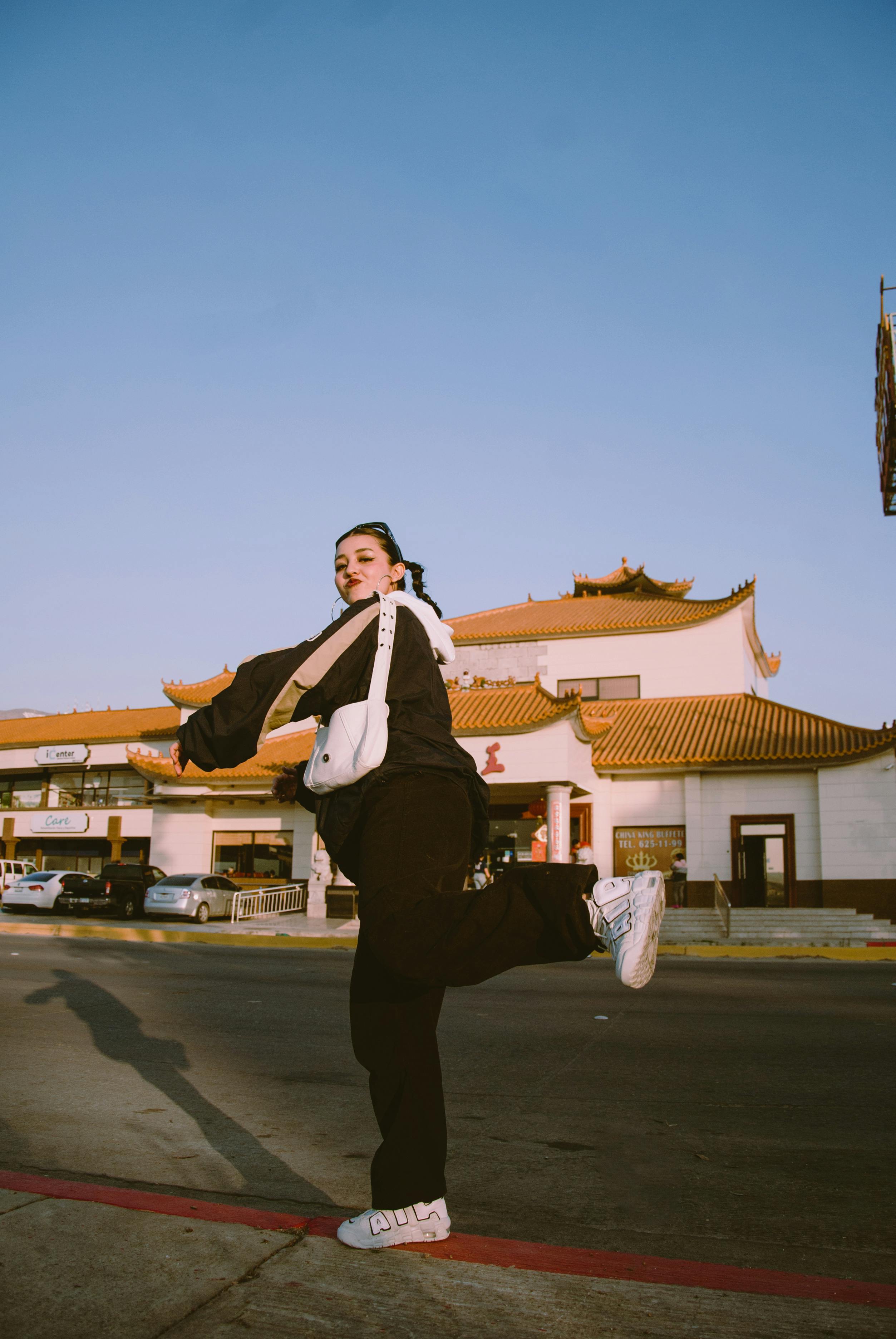 Woman Posing with Leg Raised on Street · Free Stock Photo