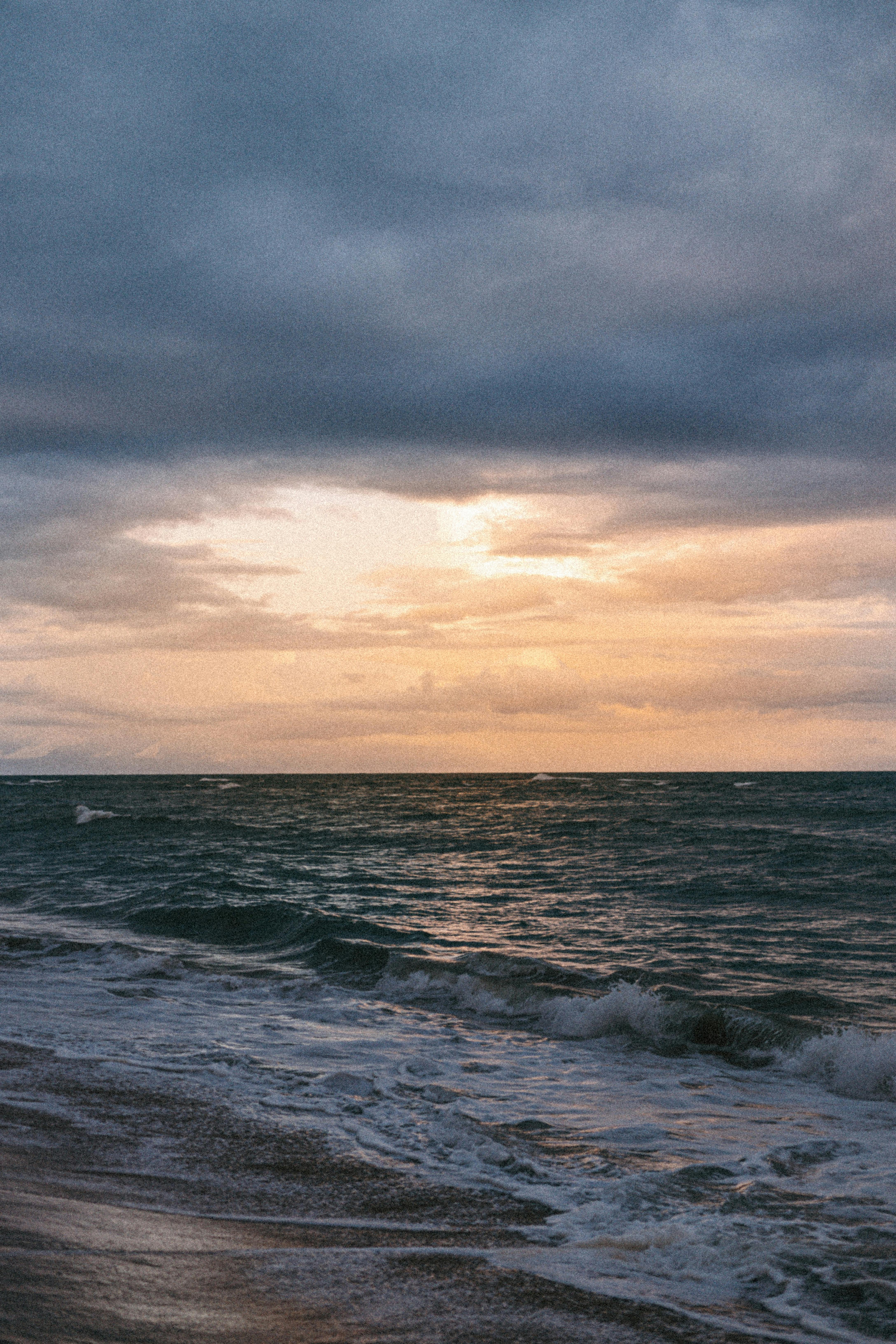 Overcast over Sea Shore at Sunset · Free Stock Photo