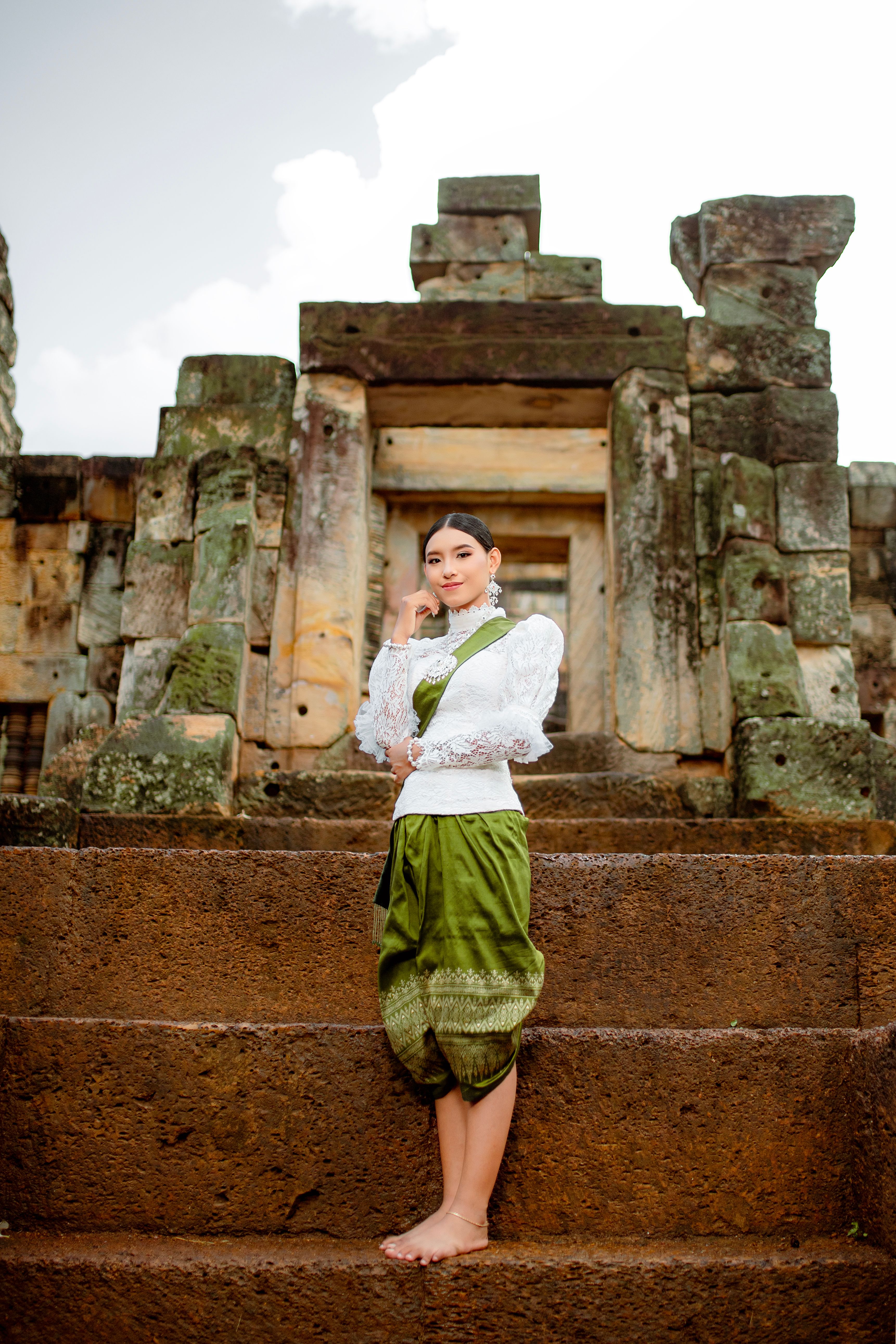 Young Woman in Traditional Clothing Standing in front of a Temple ...