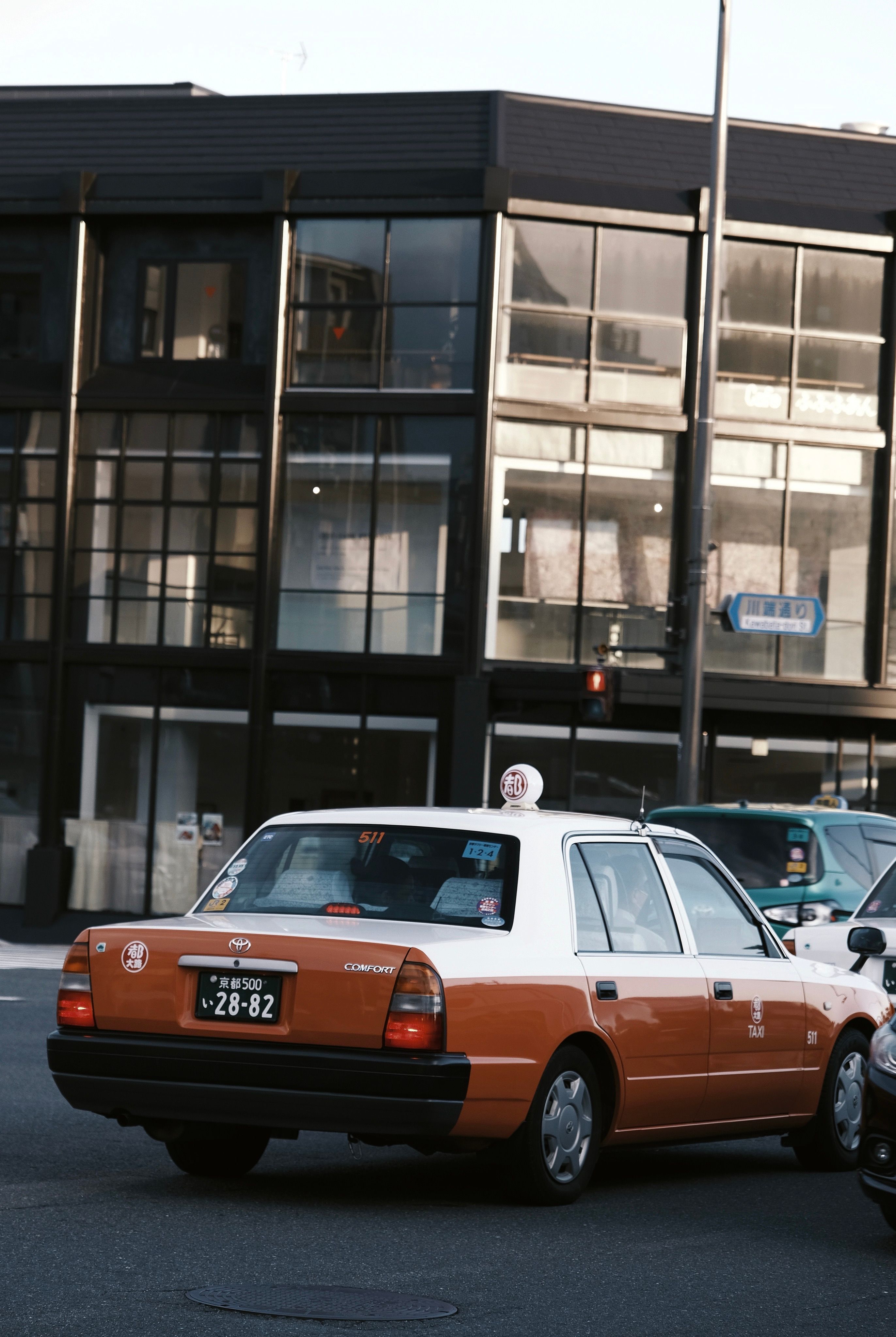 A Toyota Comfort Taxi on the Street in City · Free Stock Photo