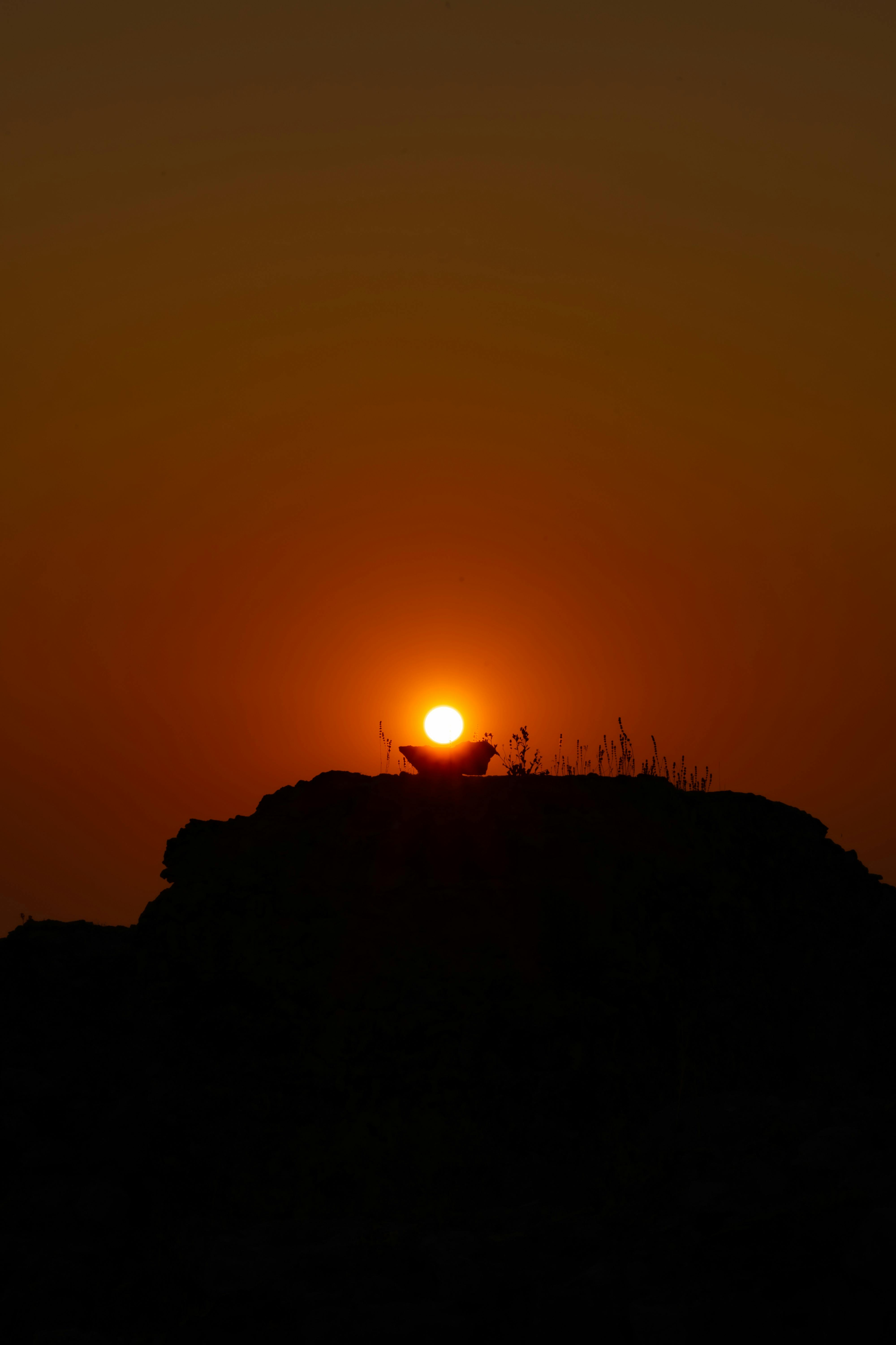 Sun over Hill Silhouette at Sunset · Free Stock Photo