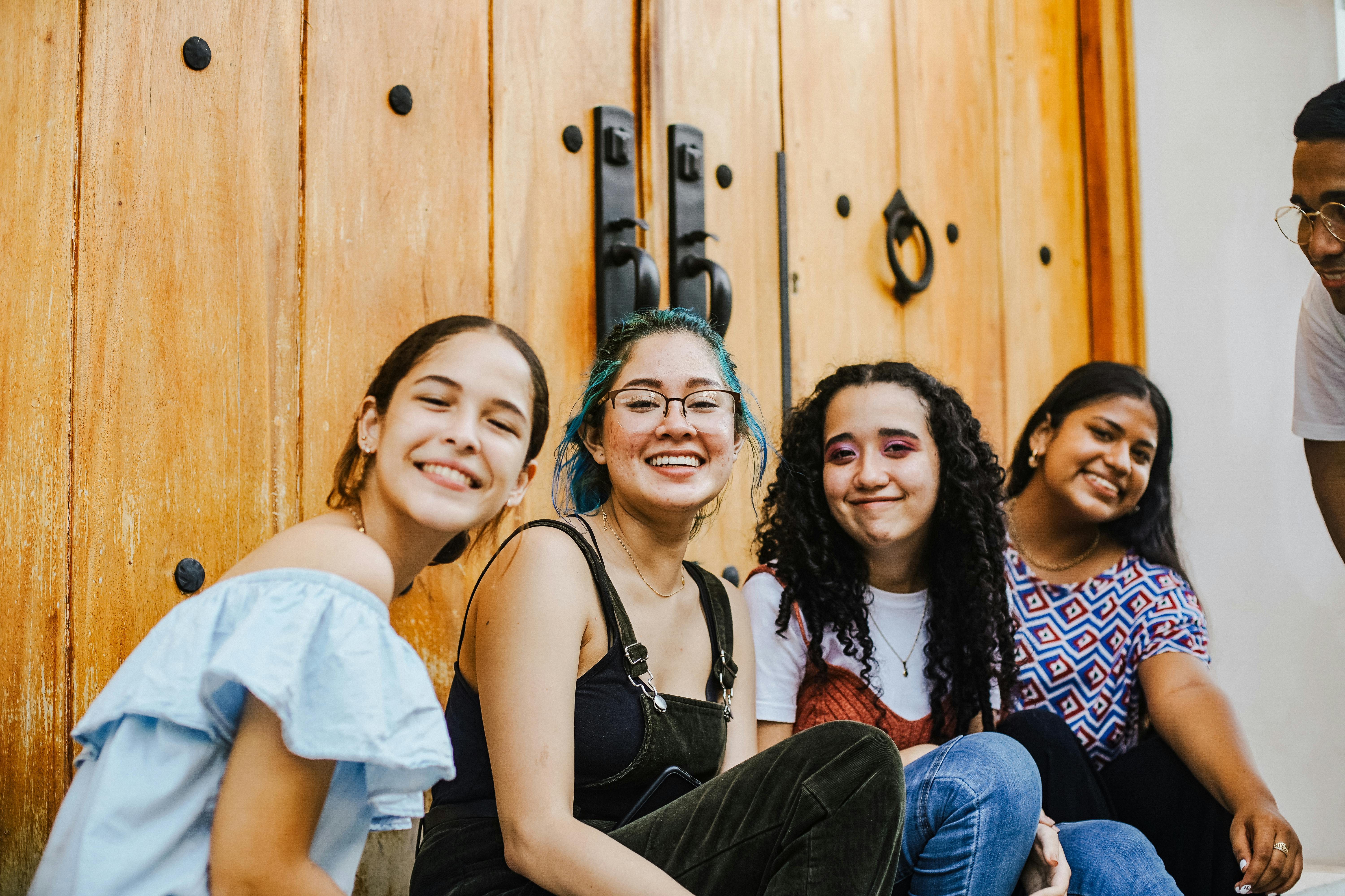 A group of young people sitting on the steps · Free Stock Photo
