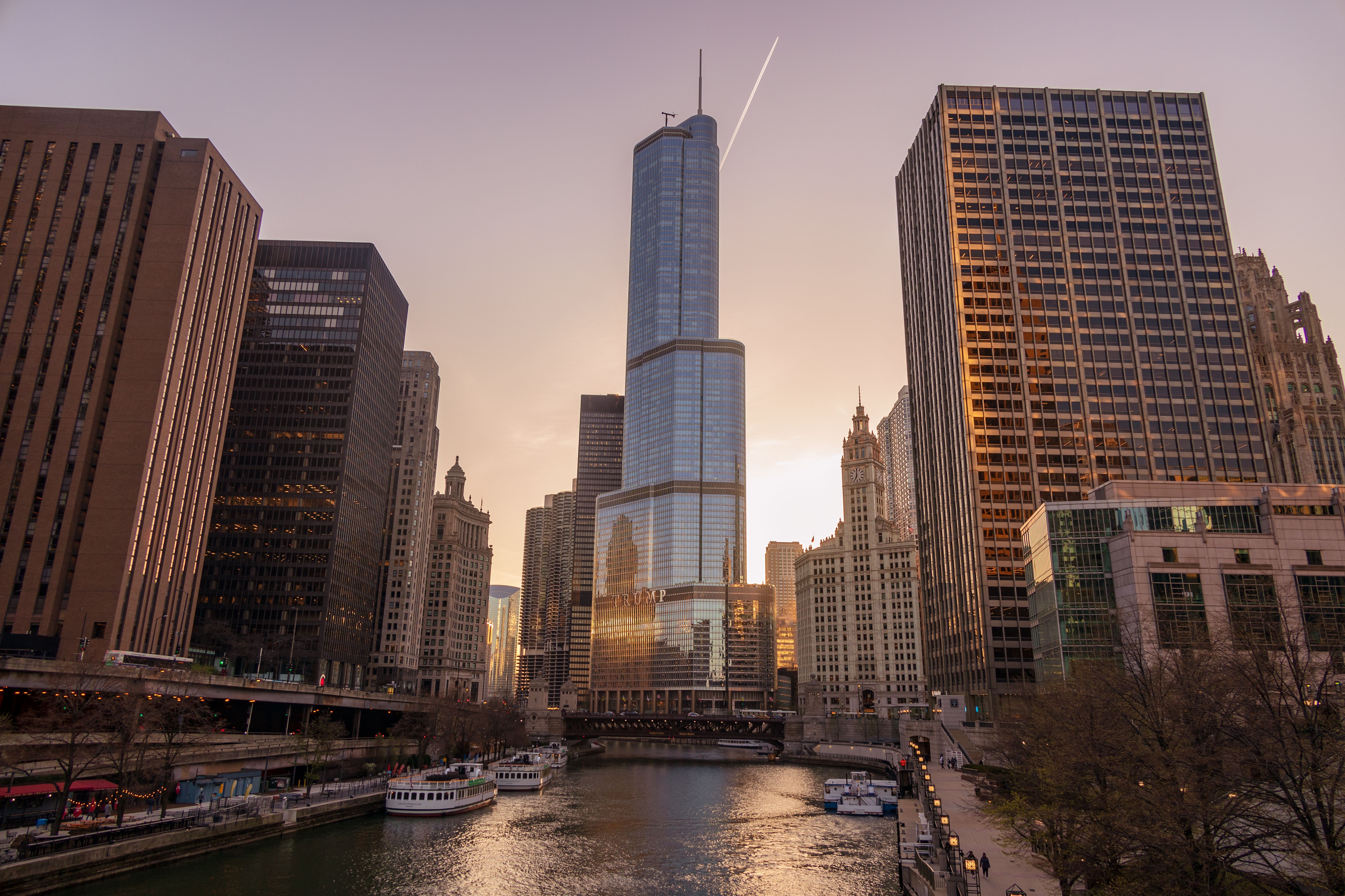 The chicago river is running through a city · Free Stock Photo