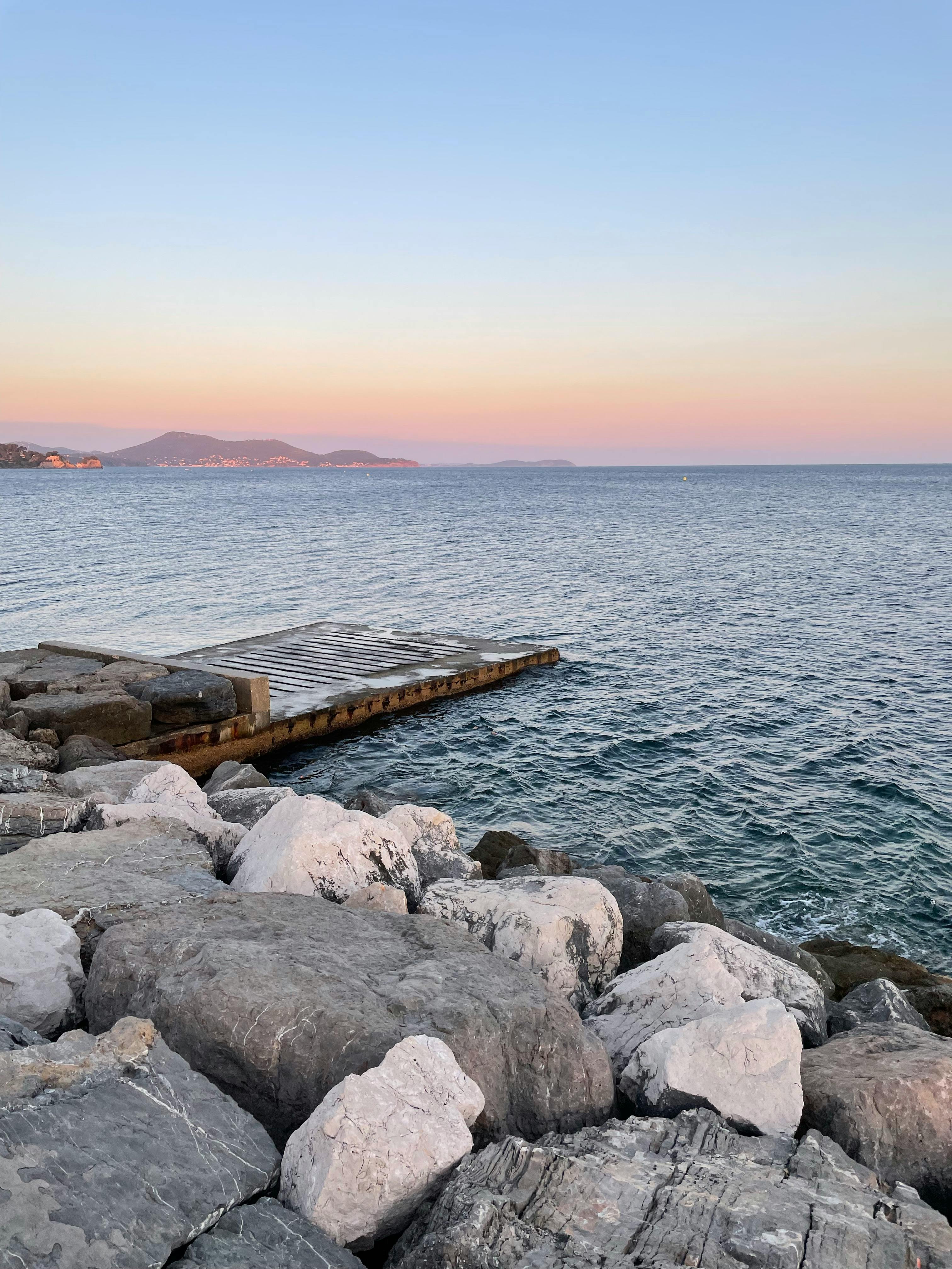 Rocks on Sea Shore at Sunset · Free Stock Photo