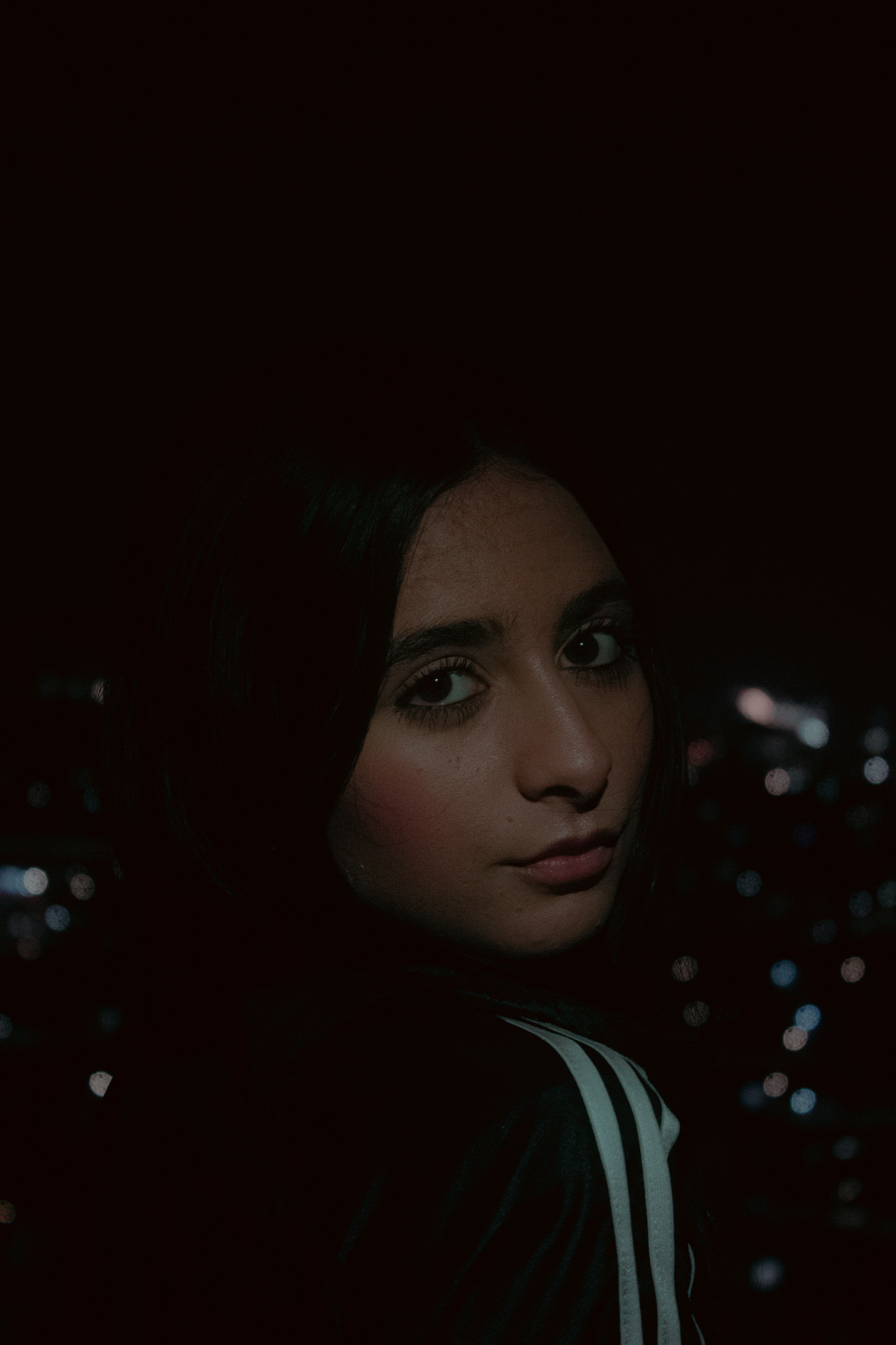 Young Woman Looking over Shoulder · Free Stock Photo
