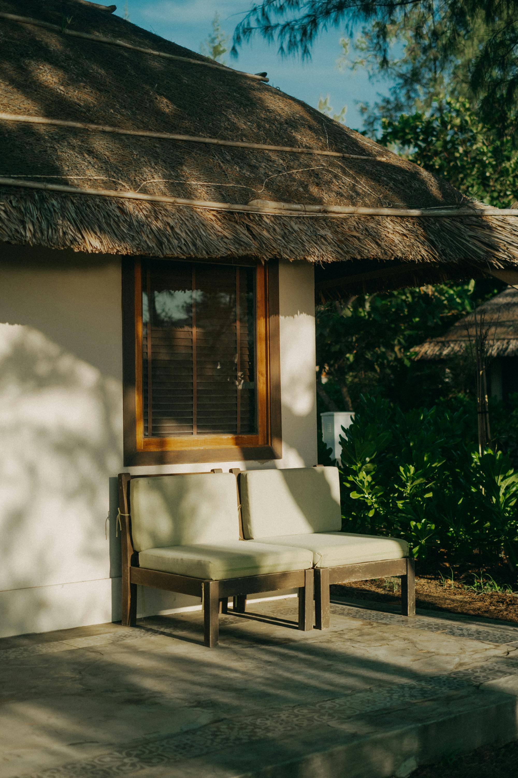 Chairs in Front of a Residential House with Thatched Roof · Free Stock ...