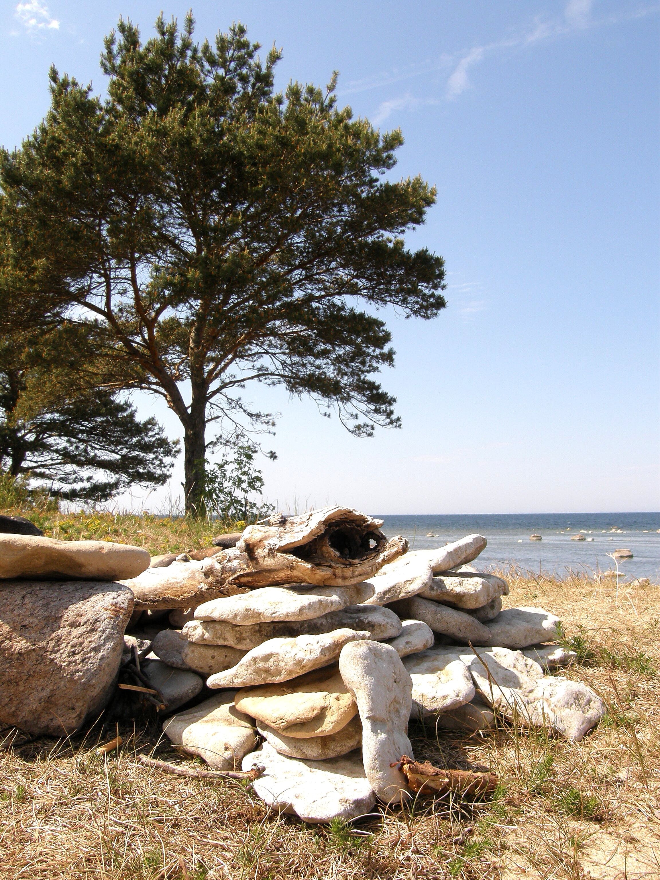 A Pile of Stones on the Shore and Sea in the Background · Free Stock Photo