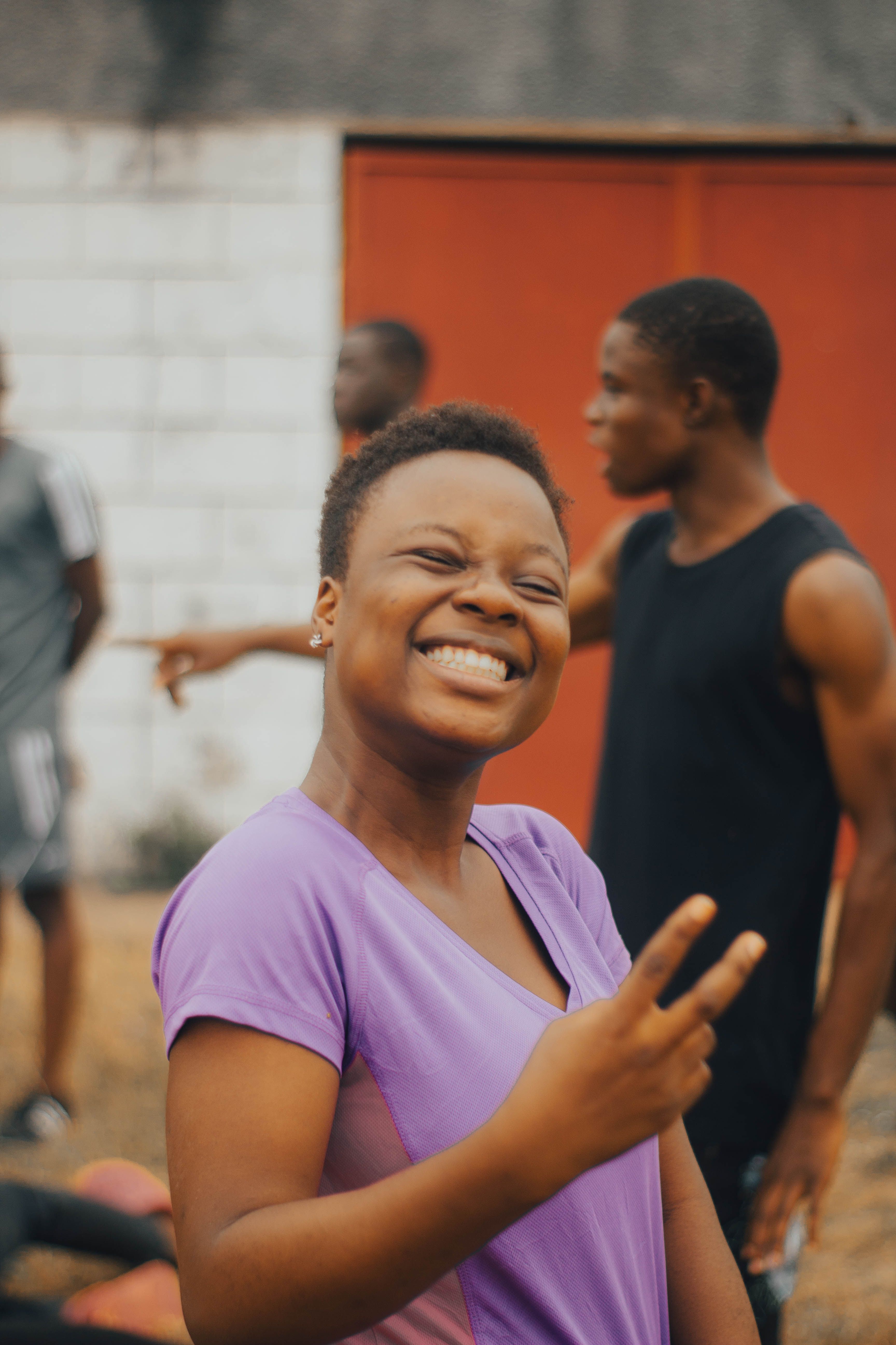 Grinning Woman Showing V Sign · Free Stock Photo