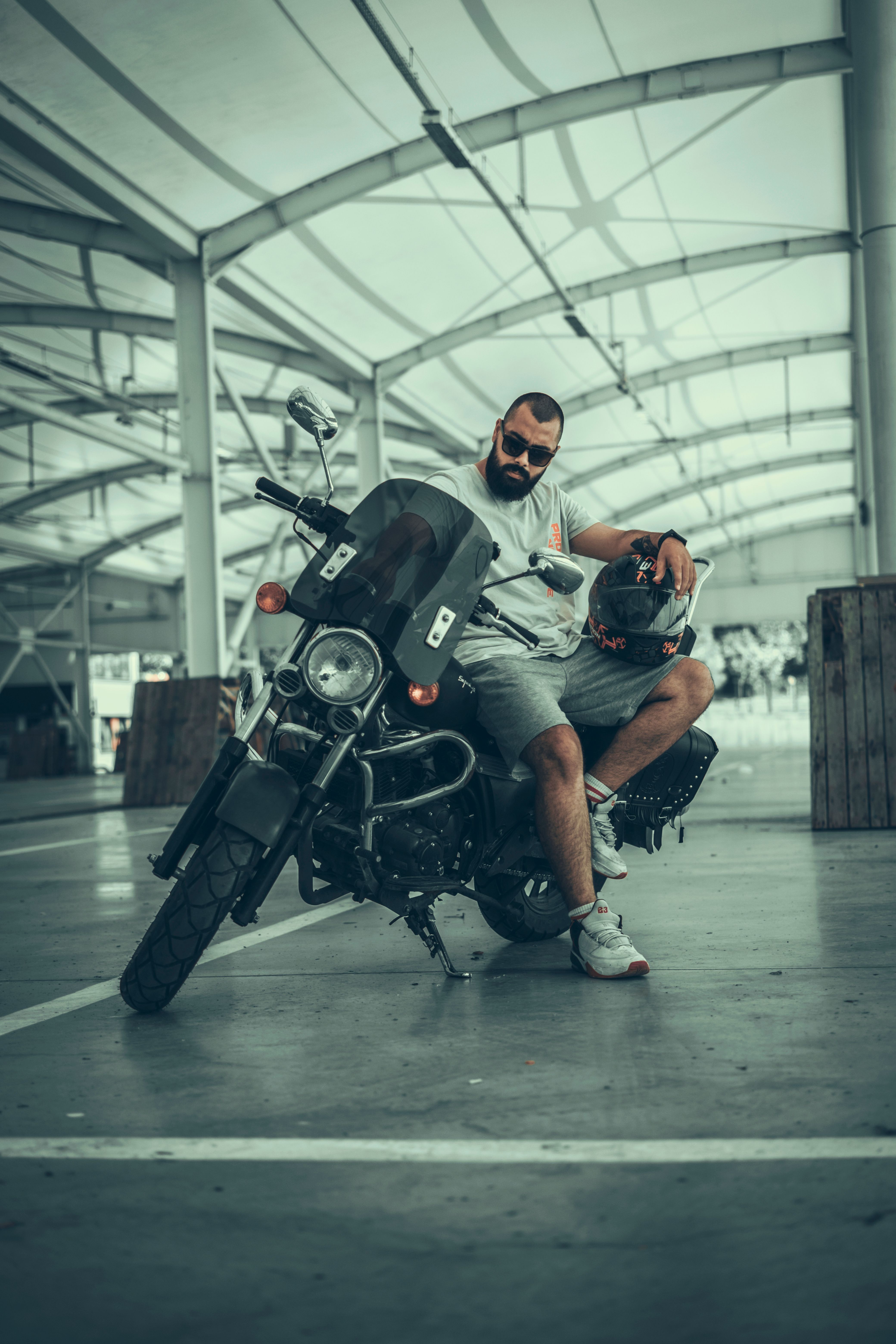 Man Sitting on Motorcycle inside Empty Hall · Free Stock Photo