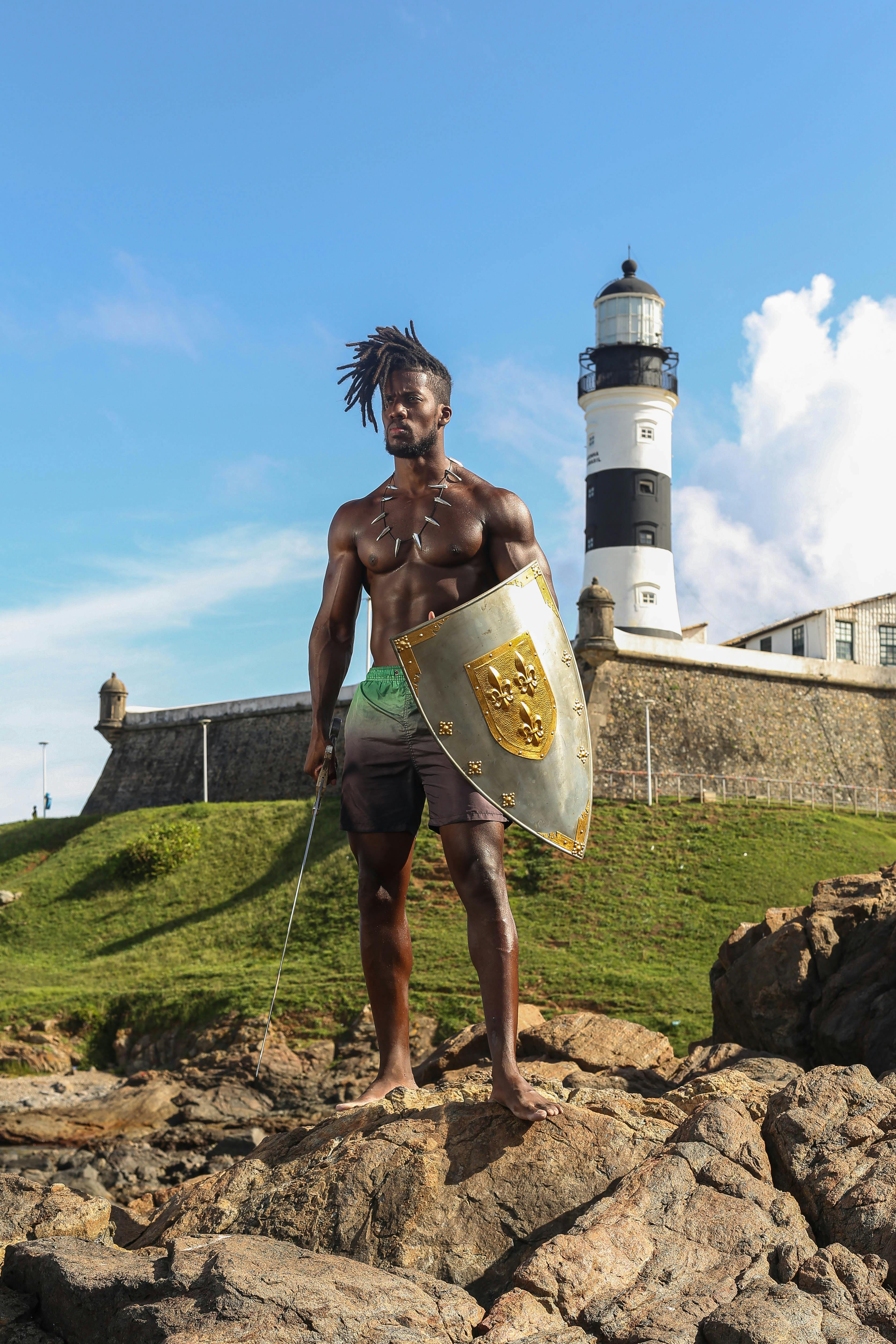 Fit Man in Shorts and a Black Panther Necklace Posing with a Medieval ...