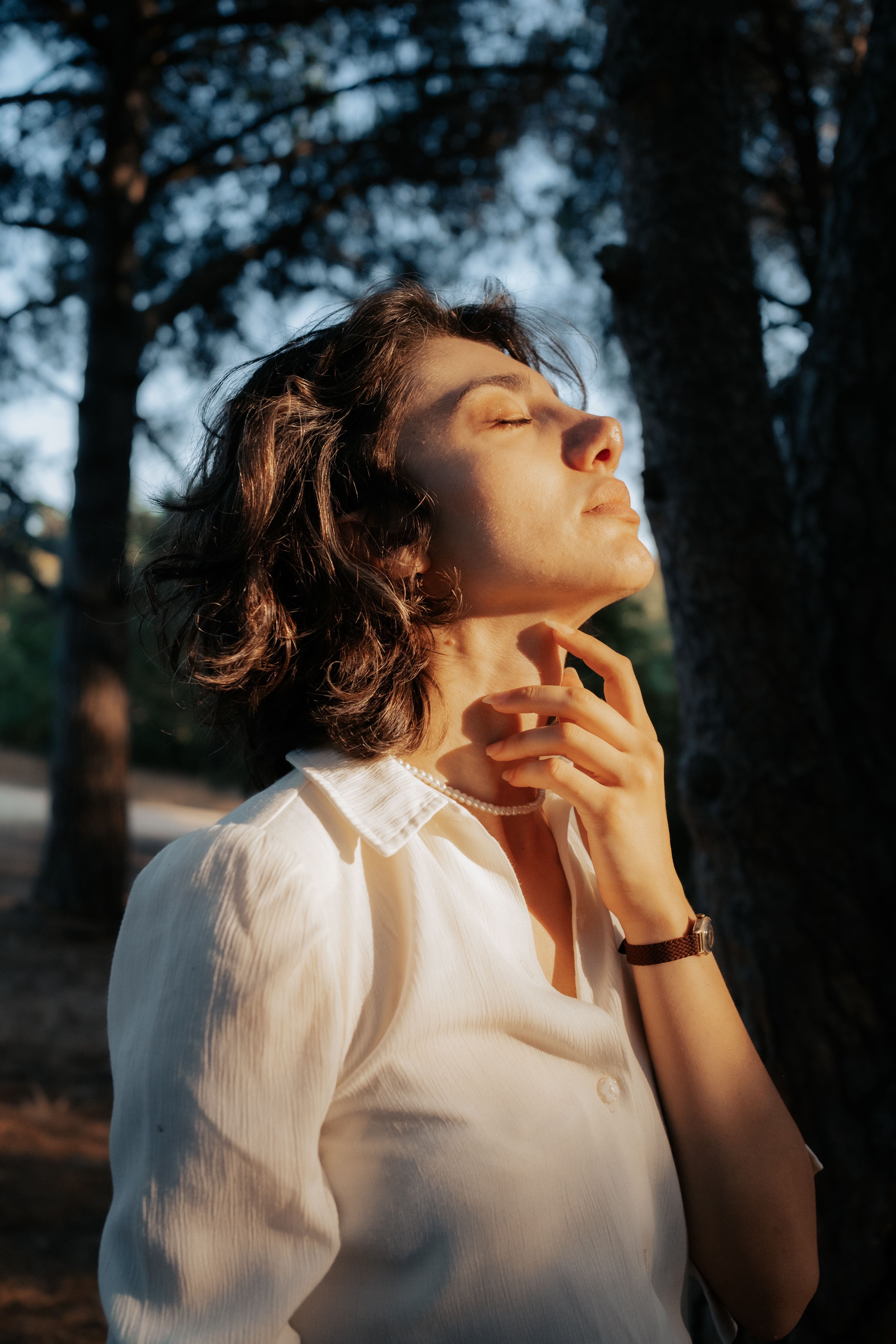 Young Woman Standing Outside and Facing the Sun with Eyes Closed · Free ...