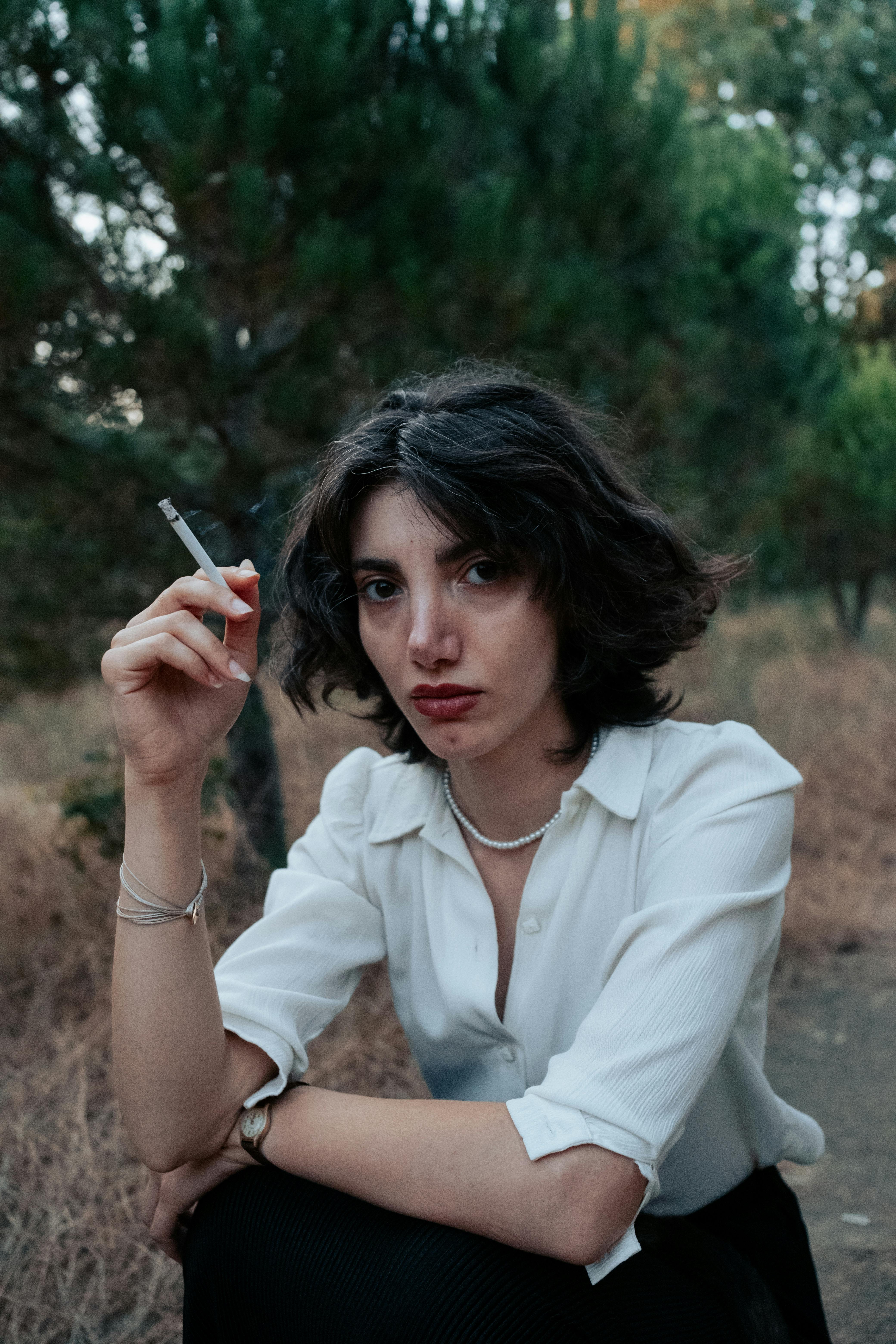 Young Elegant Woman Smoking a Cigarette in the Forest · Free Stock Photo