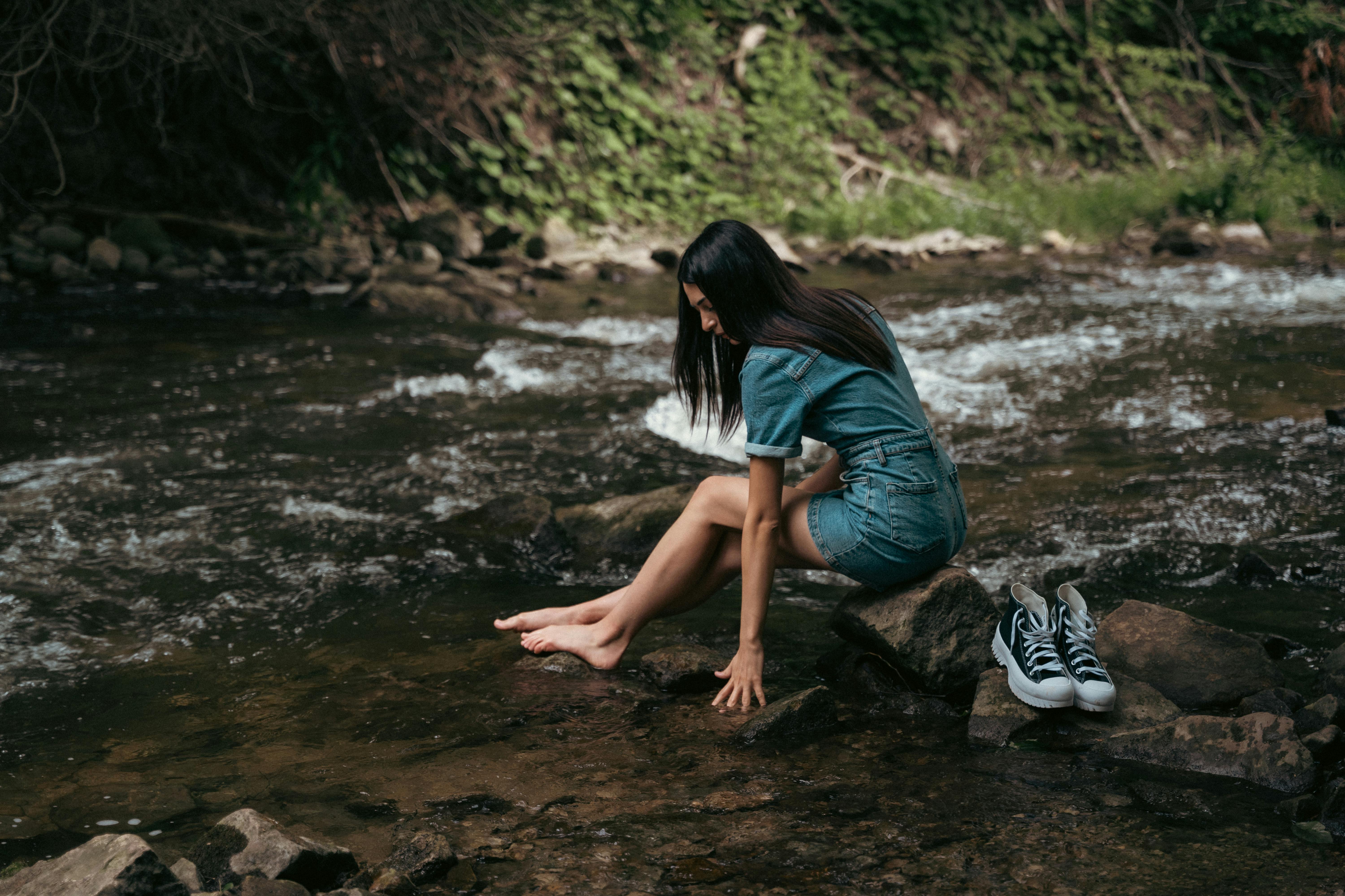 Woman Dipping Legs in a Stream · Free Stock Photo