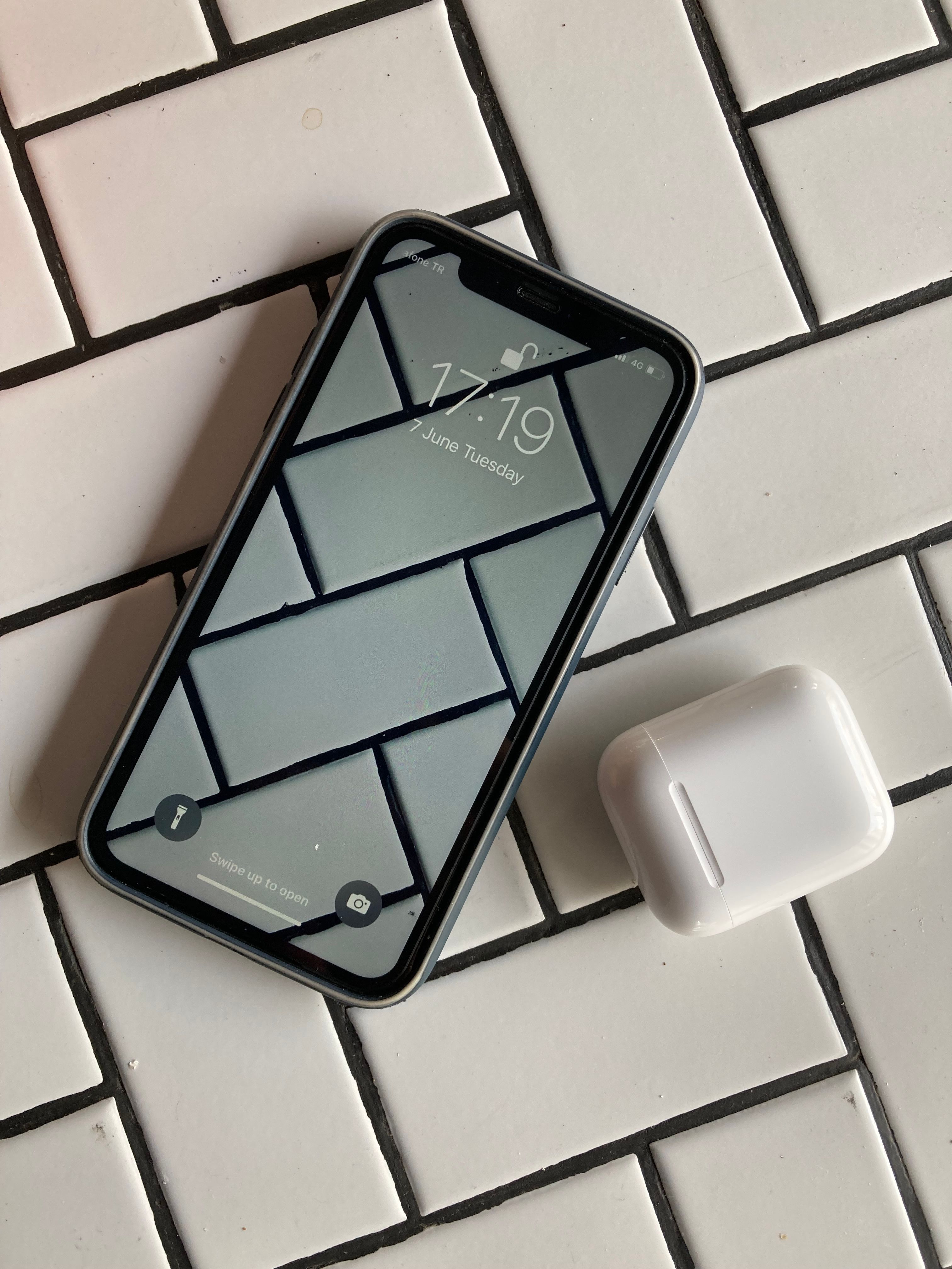 Smartphone on White Tiles · Free Stock Photo